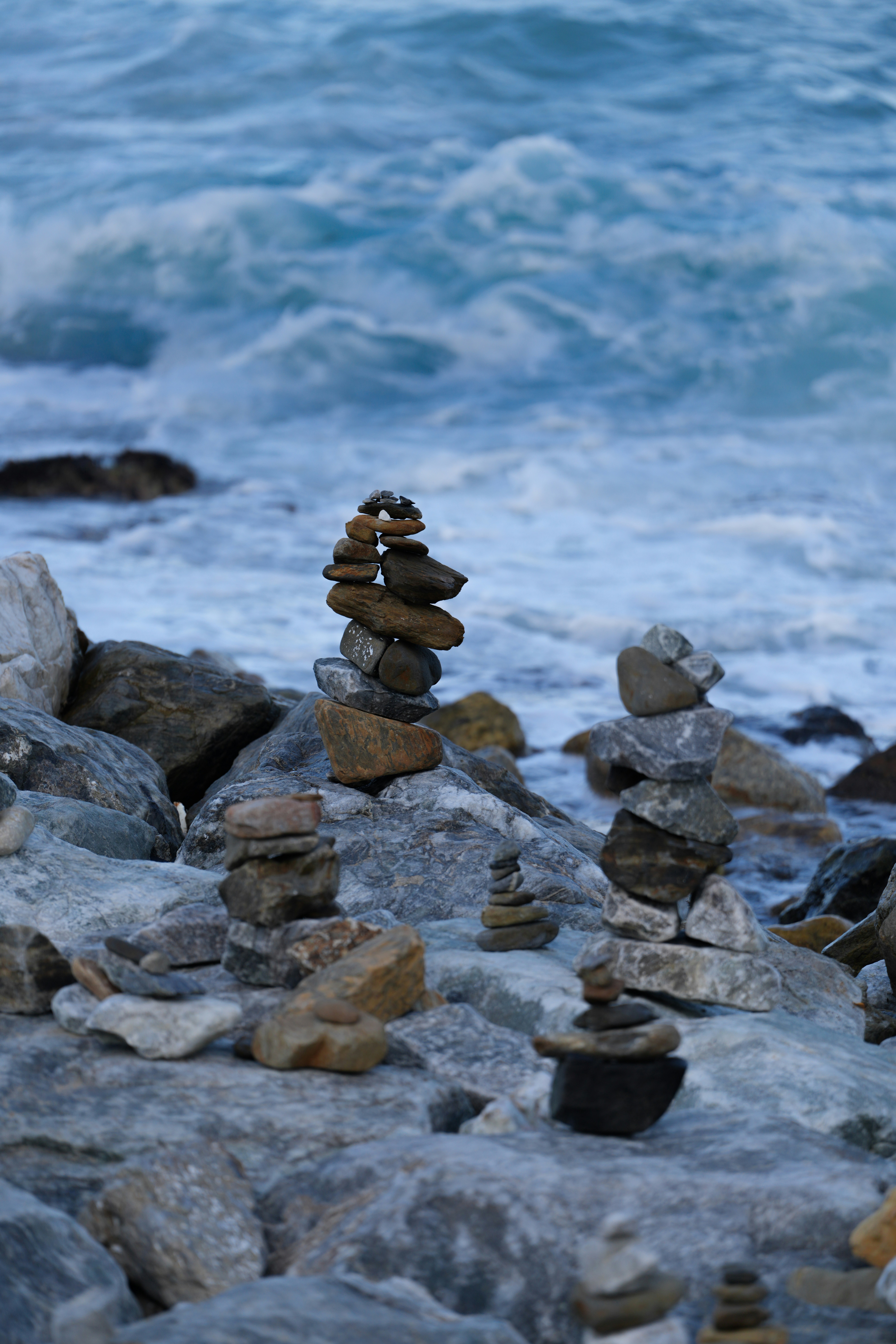 Stone Balance at the Quiet Edge: A Row of Calm Stacks by the Sea