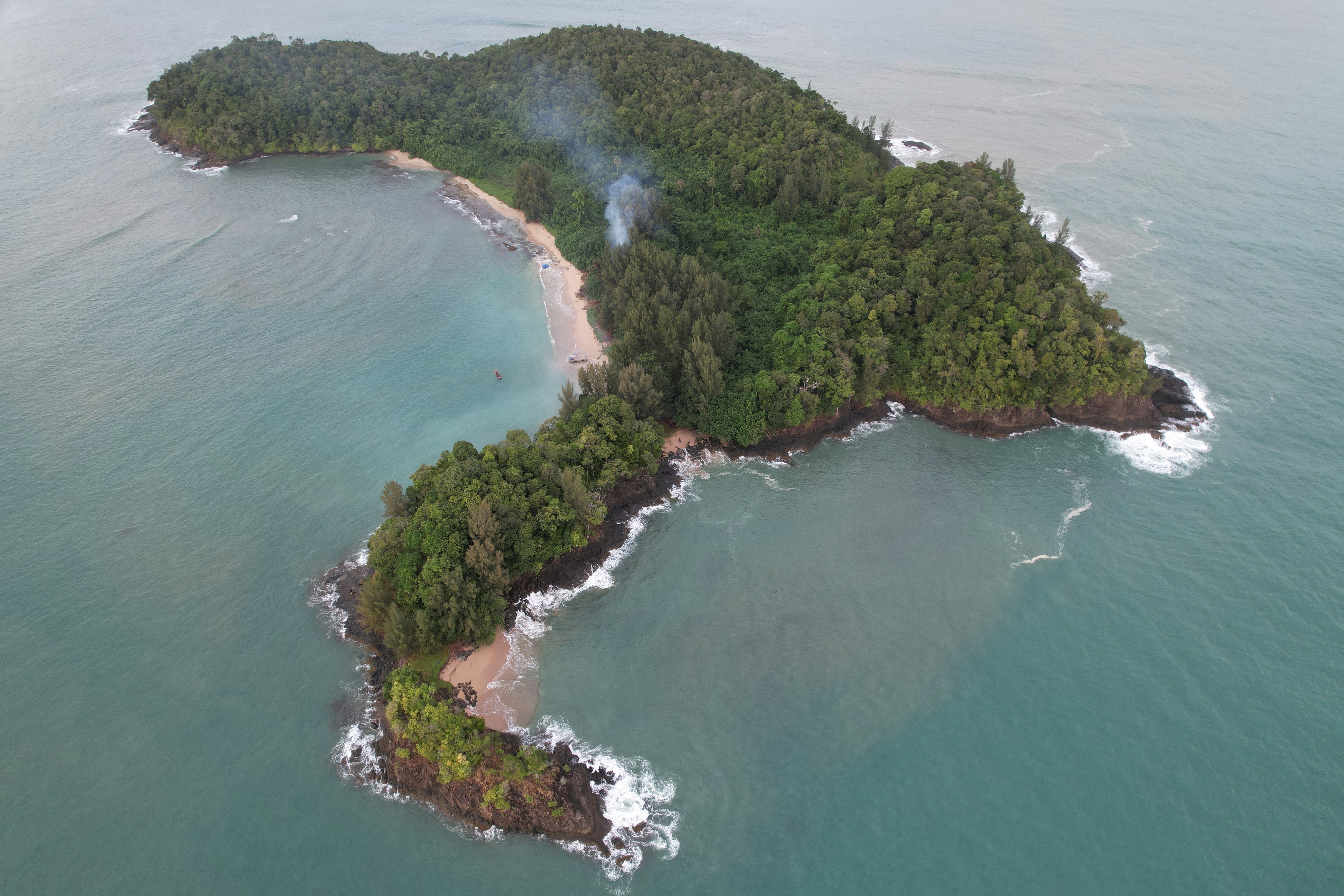 Isolated Green Belt: A C-shaped Island Slices into Turquoise Waters