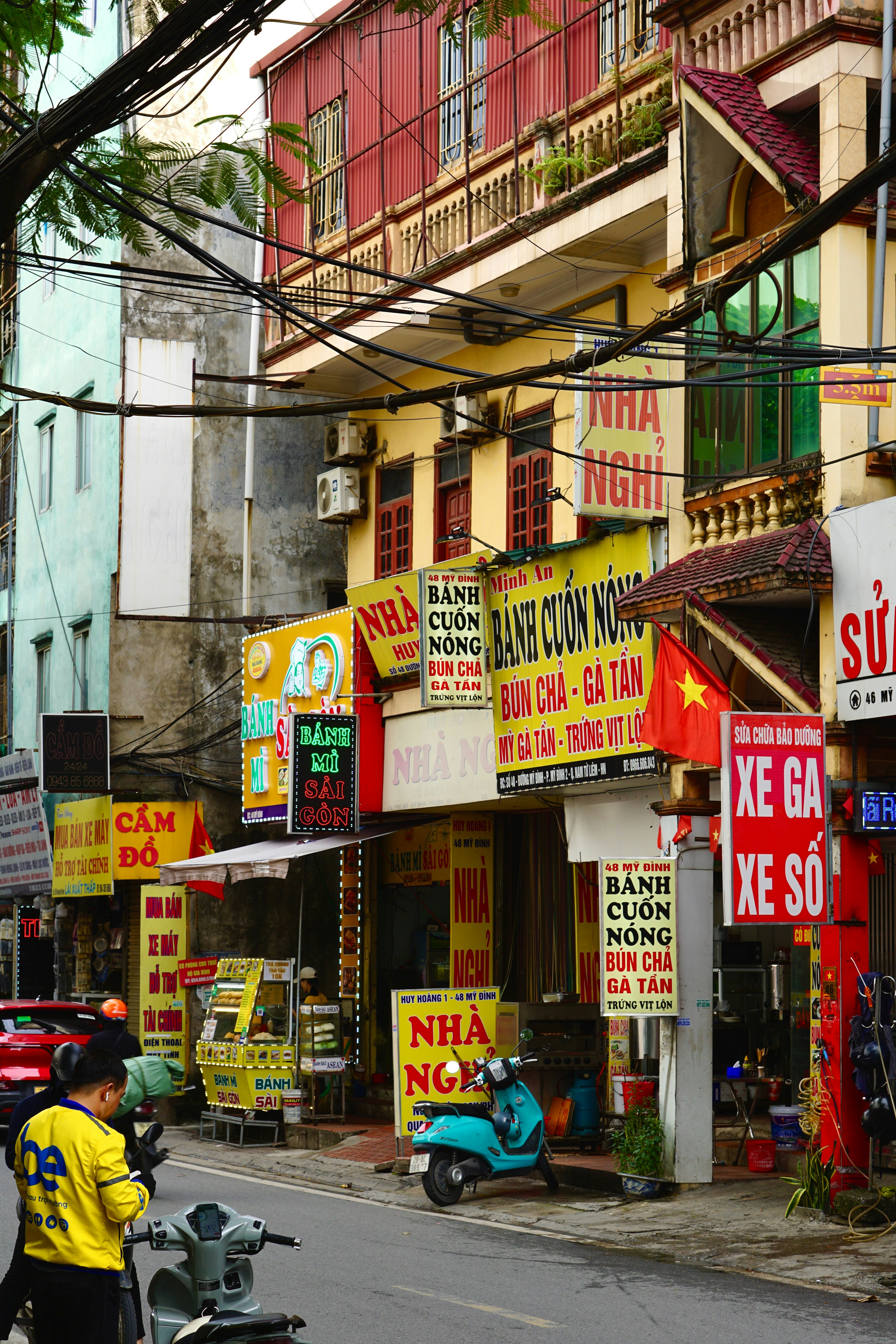 Cartography of Colorful Commerce: A Street of Signs and Scooters
