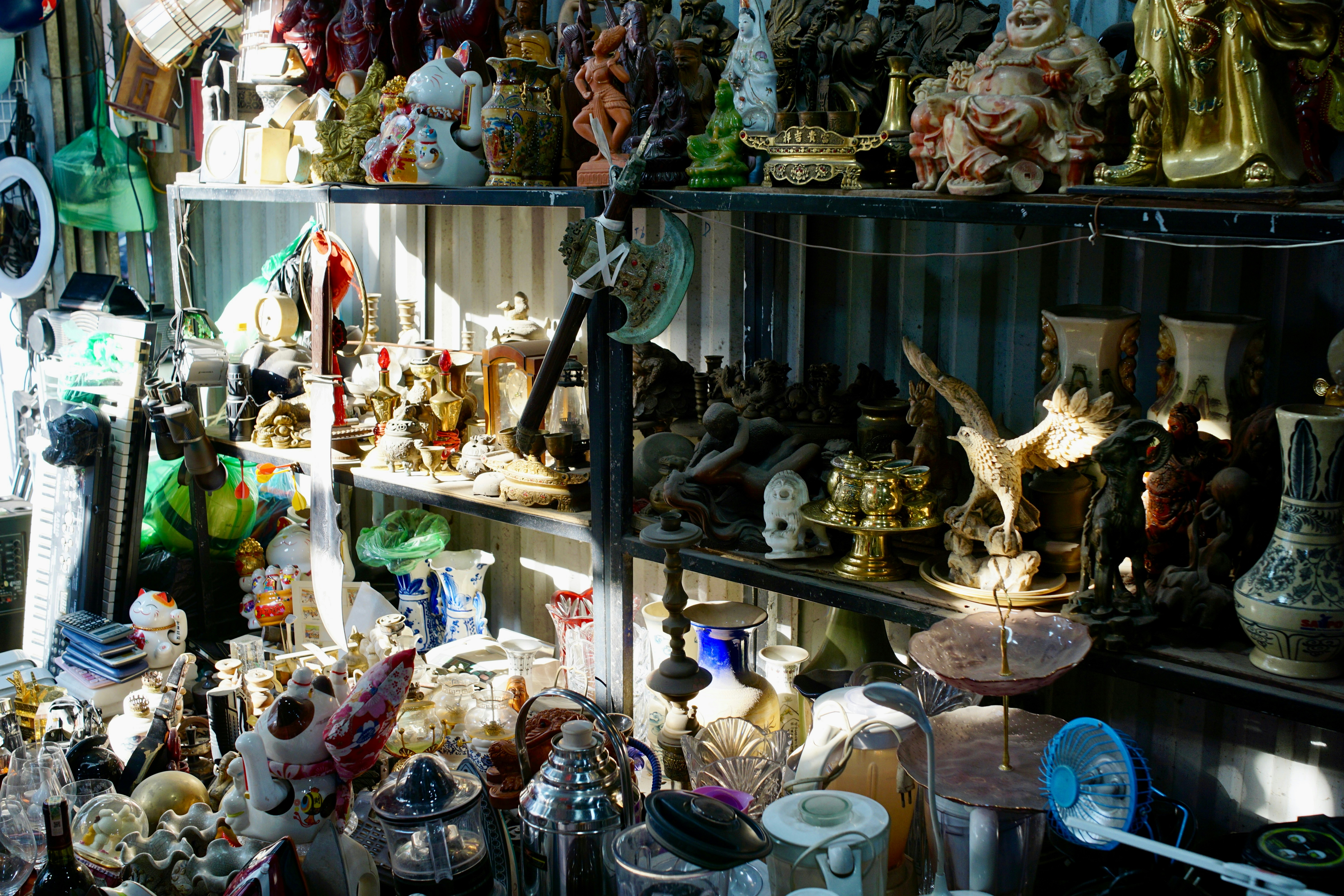 A Curio Shelf of Trinkets: Stacked Shelves Laden with Figurines and Everyday Objects