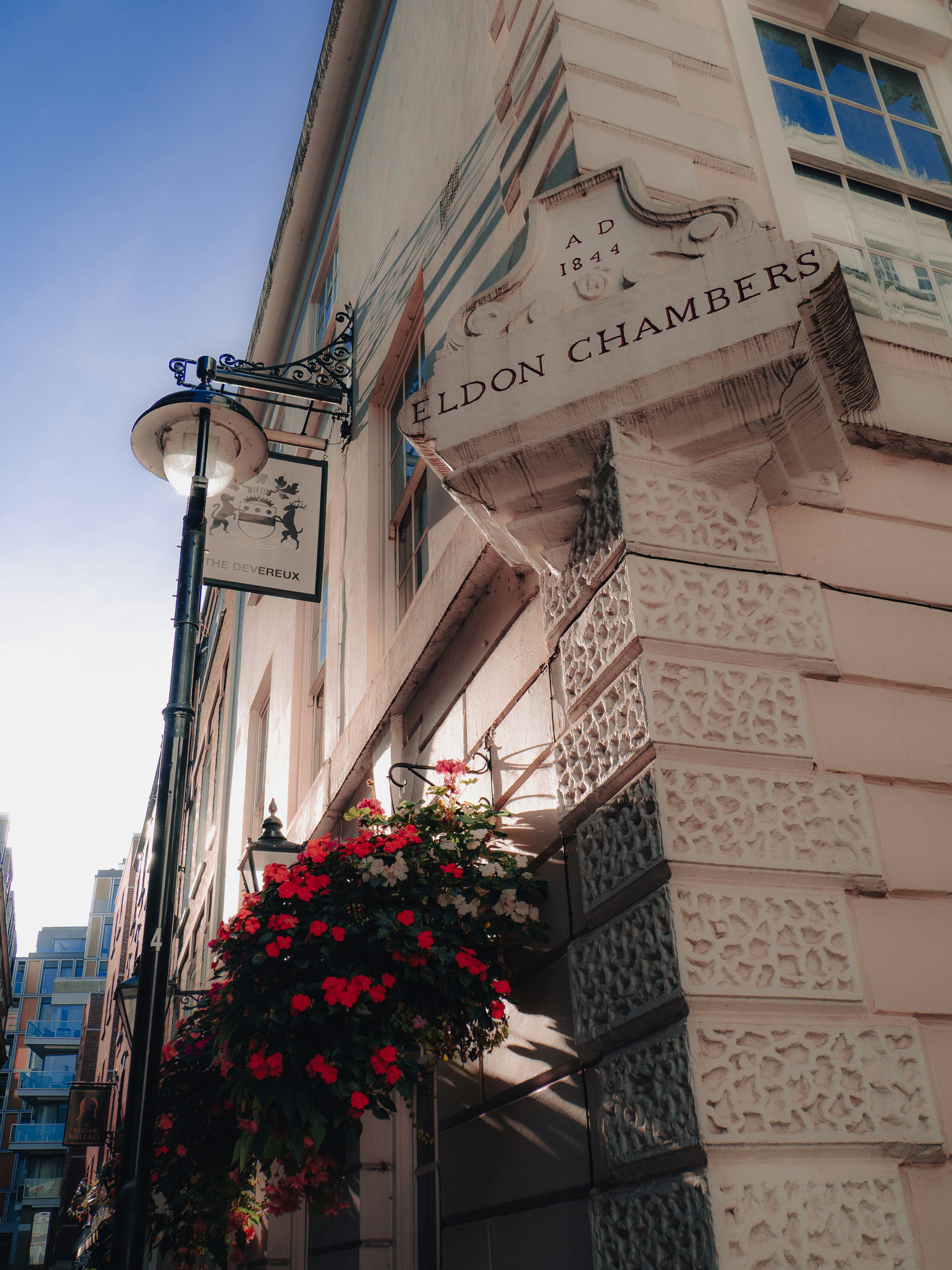 Heritage Signage and Crimson Blooms Over a London-Style Facade