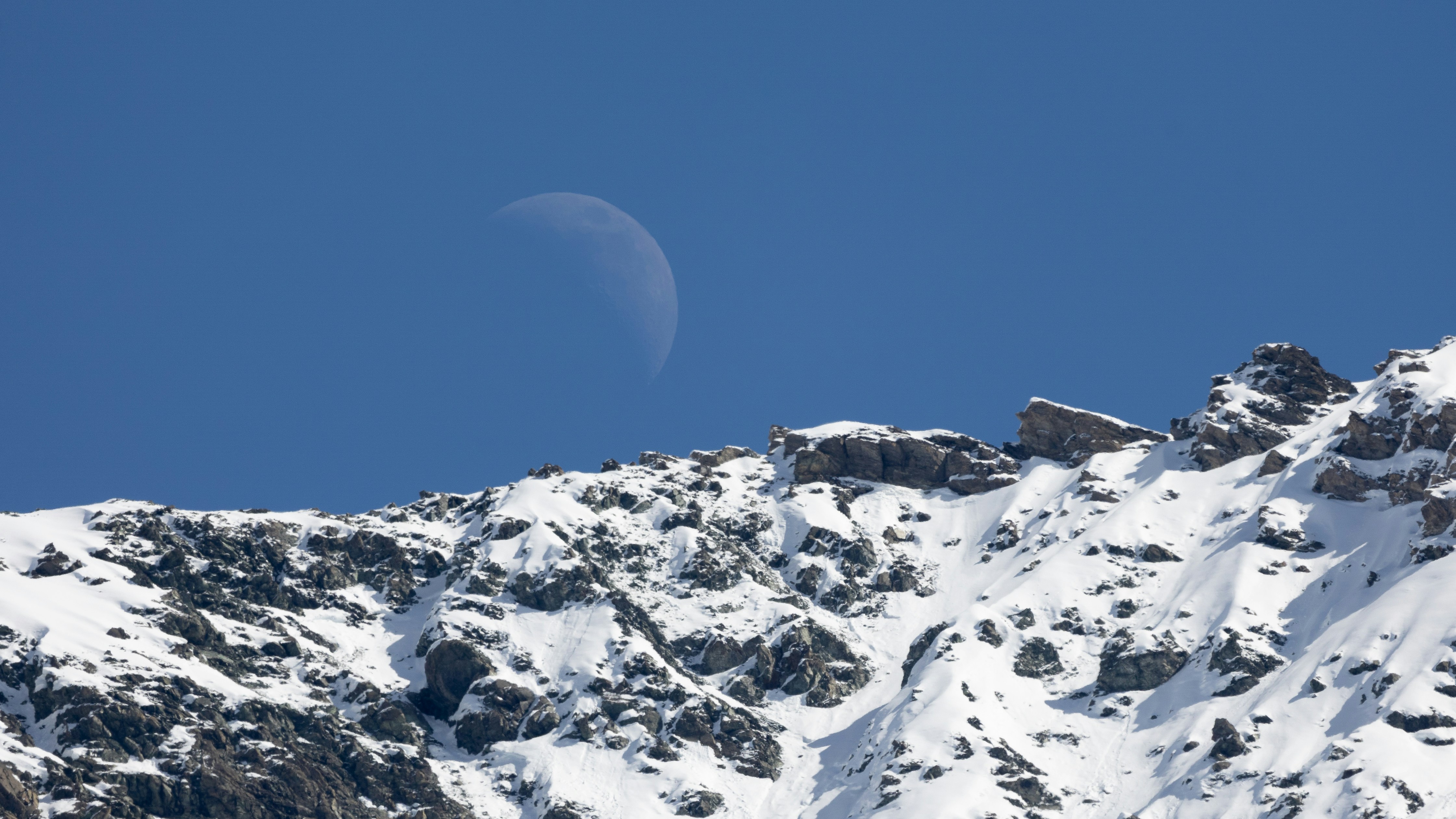 Moonrise Over Snowbound Peaks
