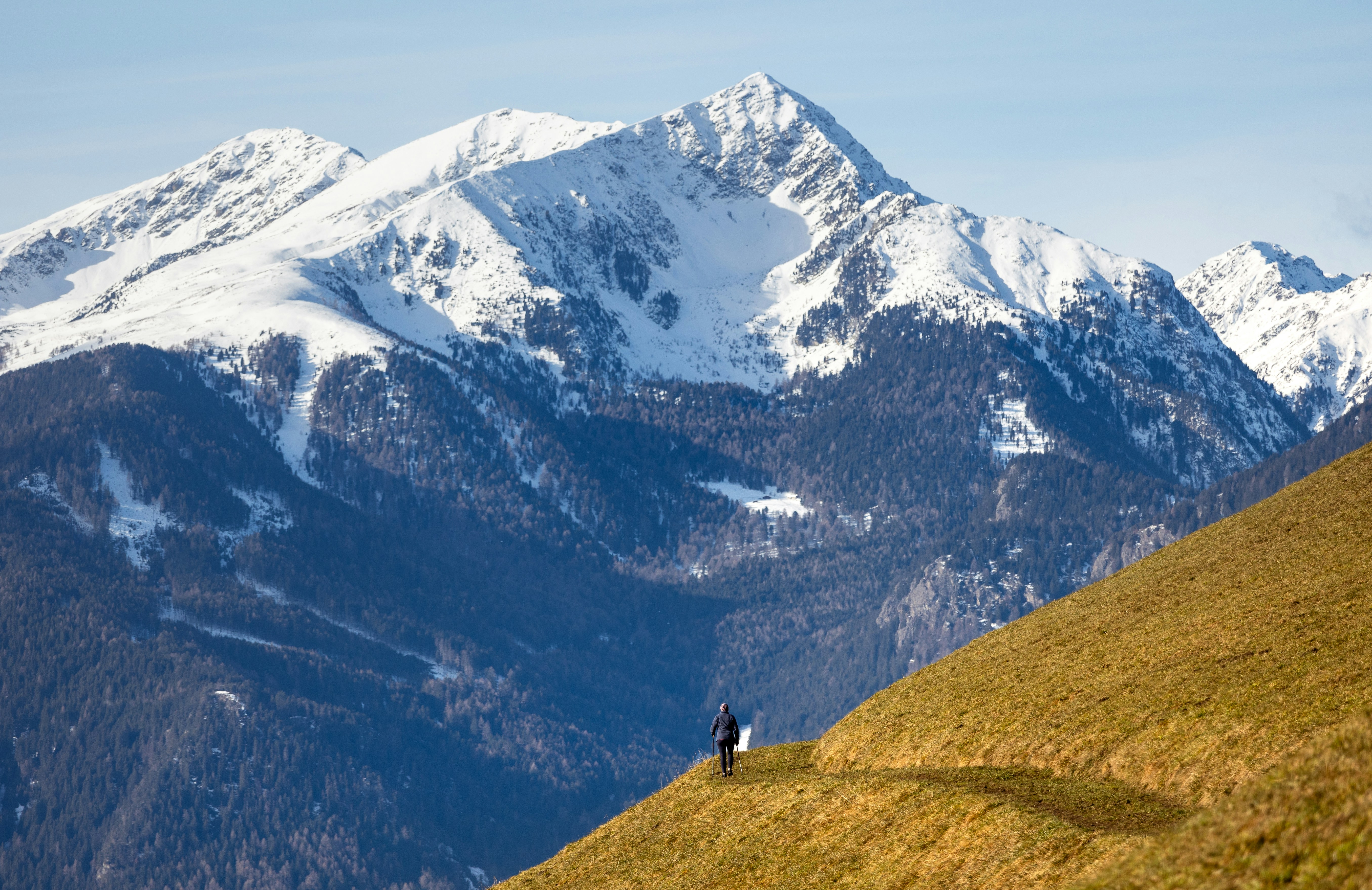 Hiker on a Golden Ridge Beneath Snow-Kissed Peaks