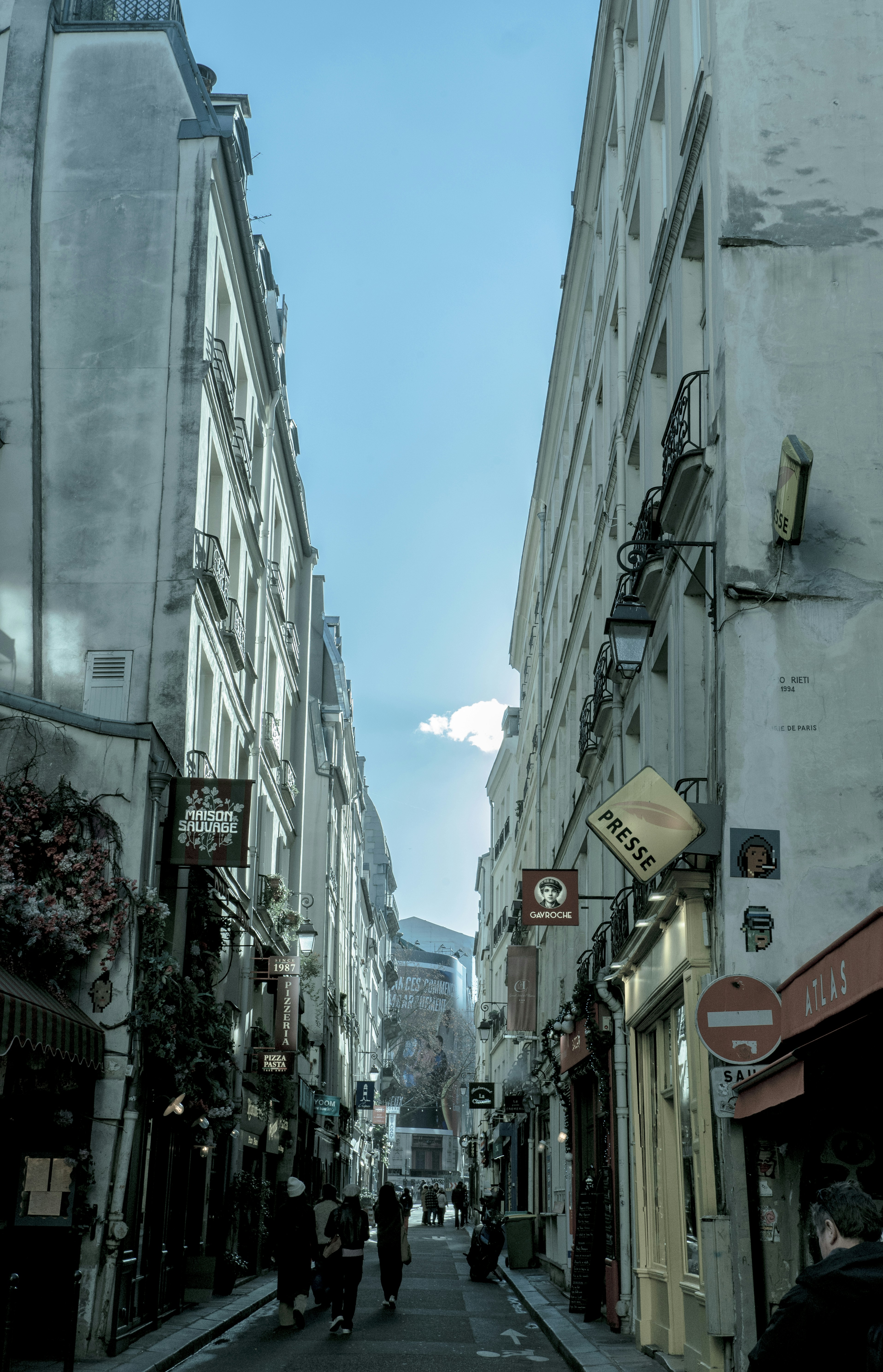 Narrow Quai, Wide Sky: A Sunlit Street Framed by Timeworn Facades