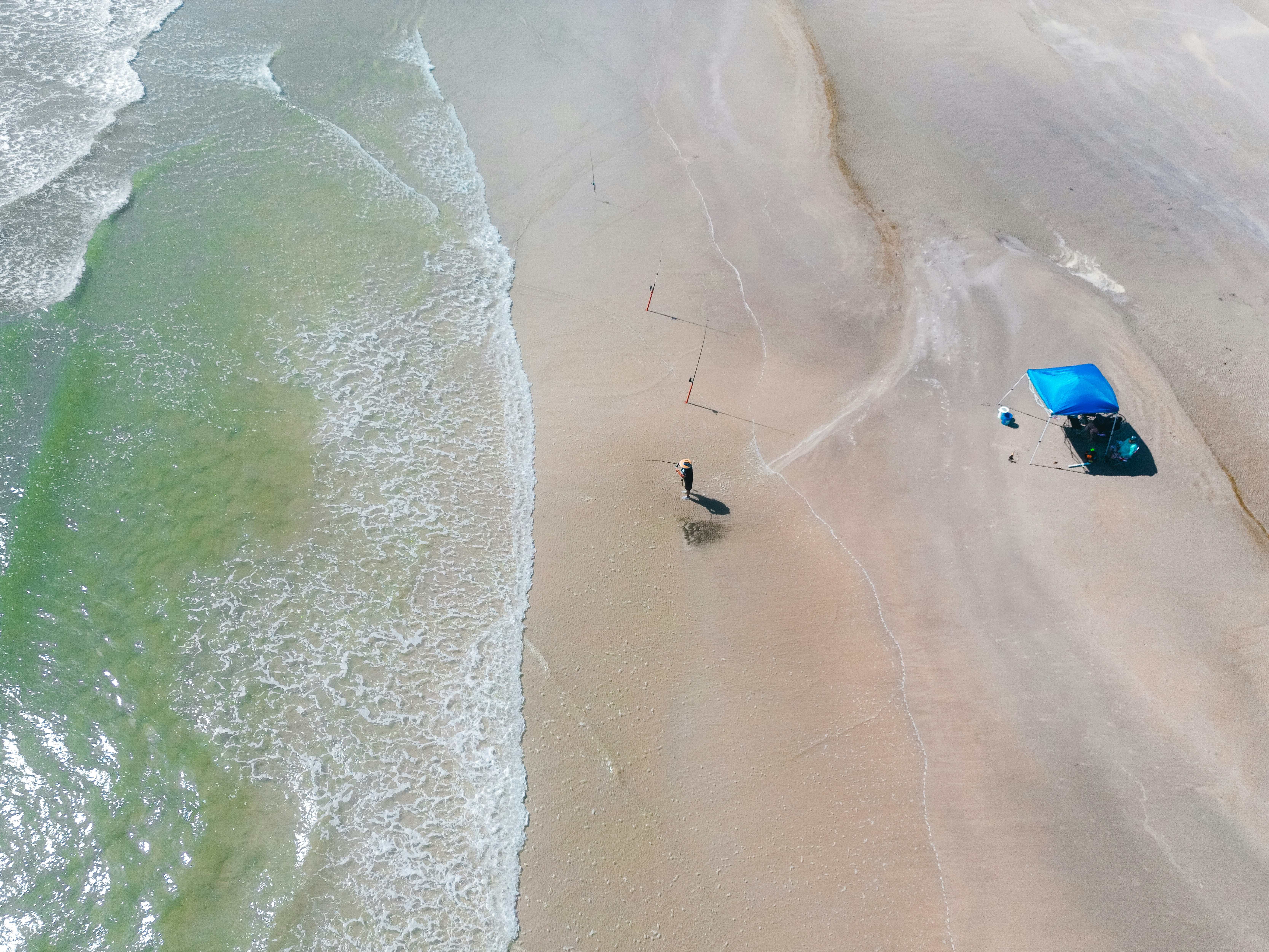 Blue Canopy over Quiet Shore: A Drone’s Sea-Trail Portrait