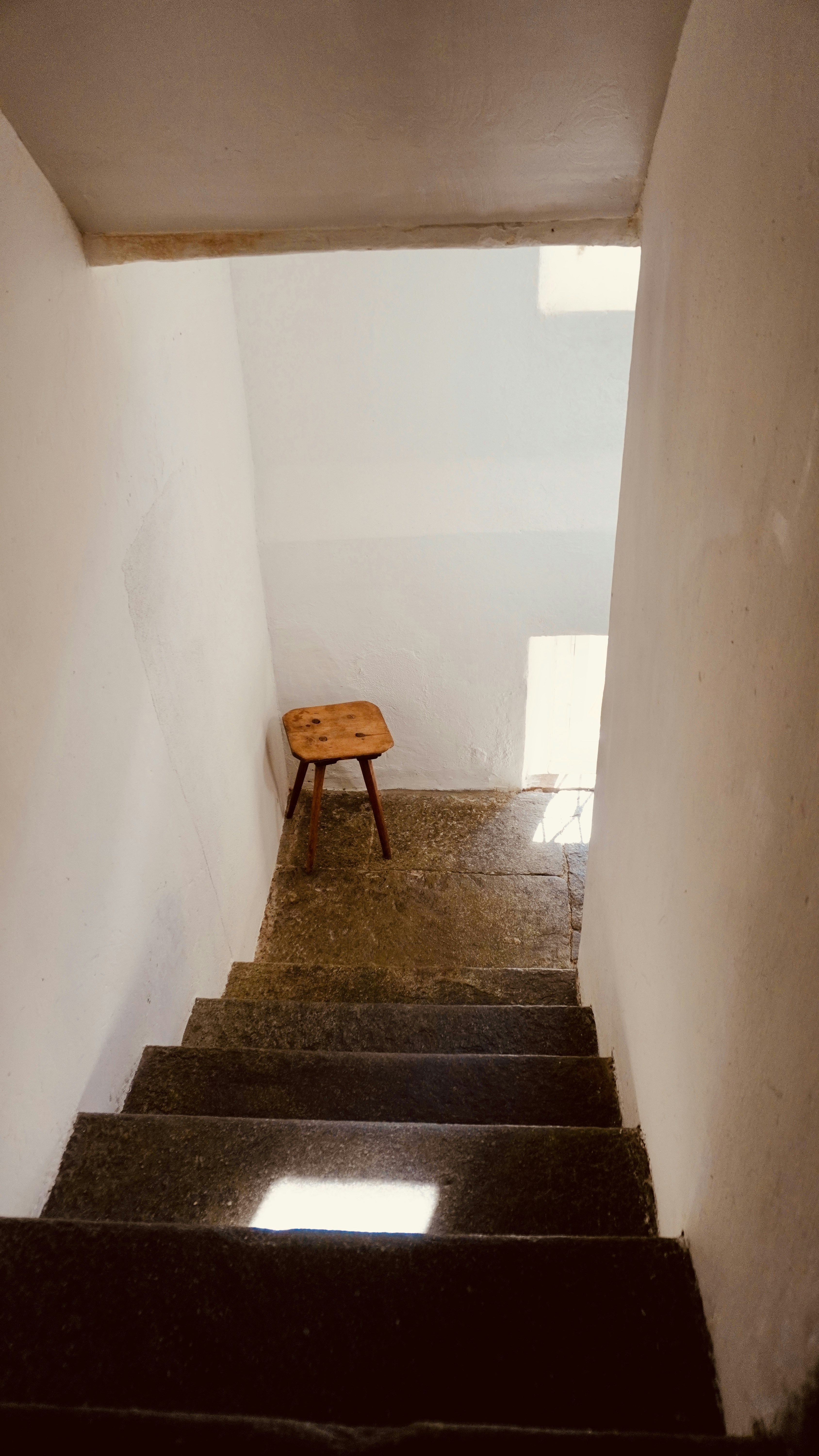 Solitary Stool at the Foot of a Stairwell