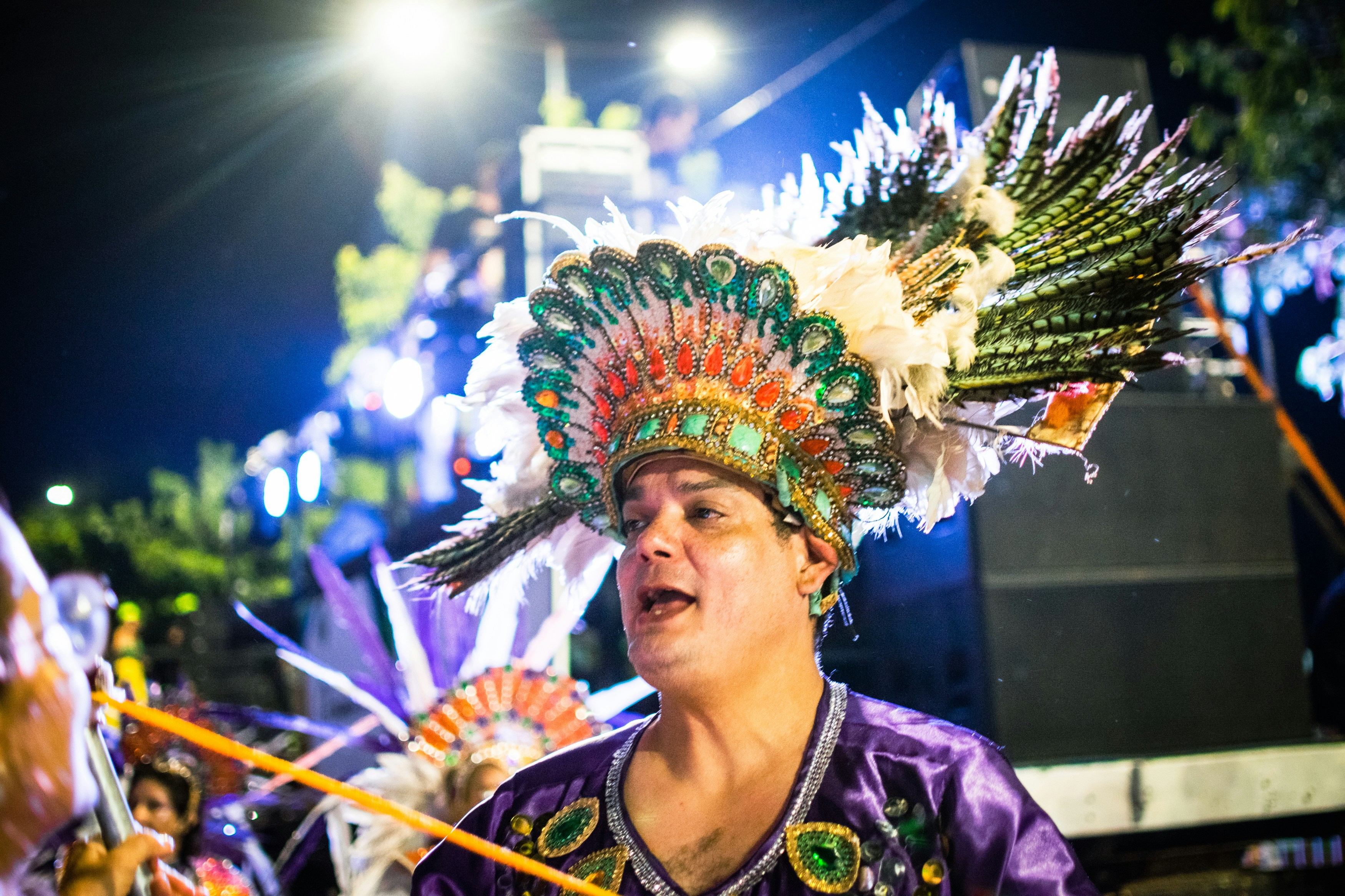 Carnival Headdress in Motion: A Dazzling Performer Under Night Lights
