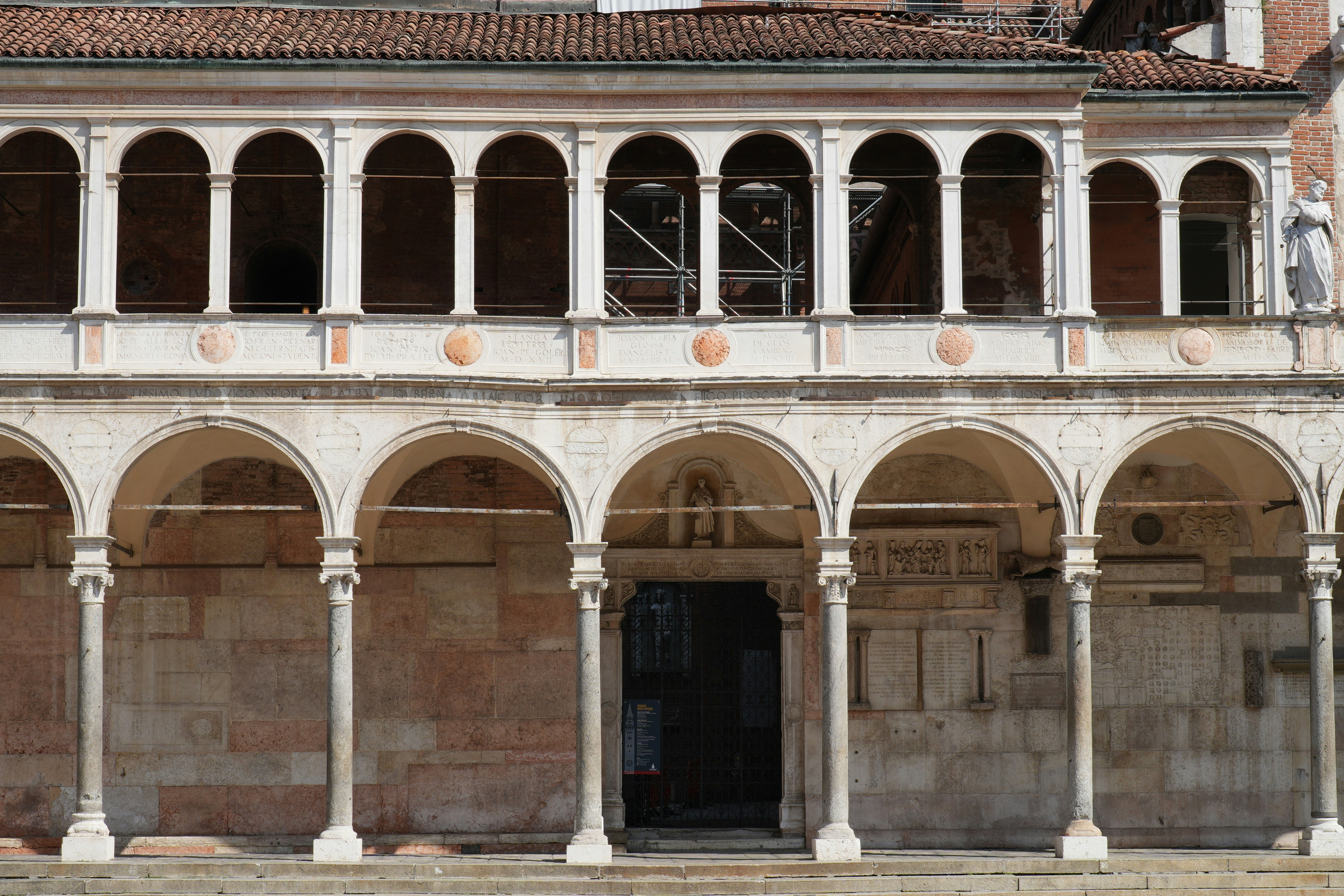 Arched Cloister Rows: façade of a historic courtyard viewed from the ground level