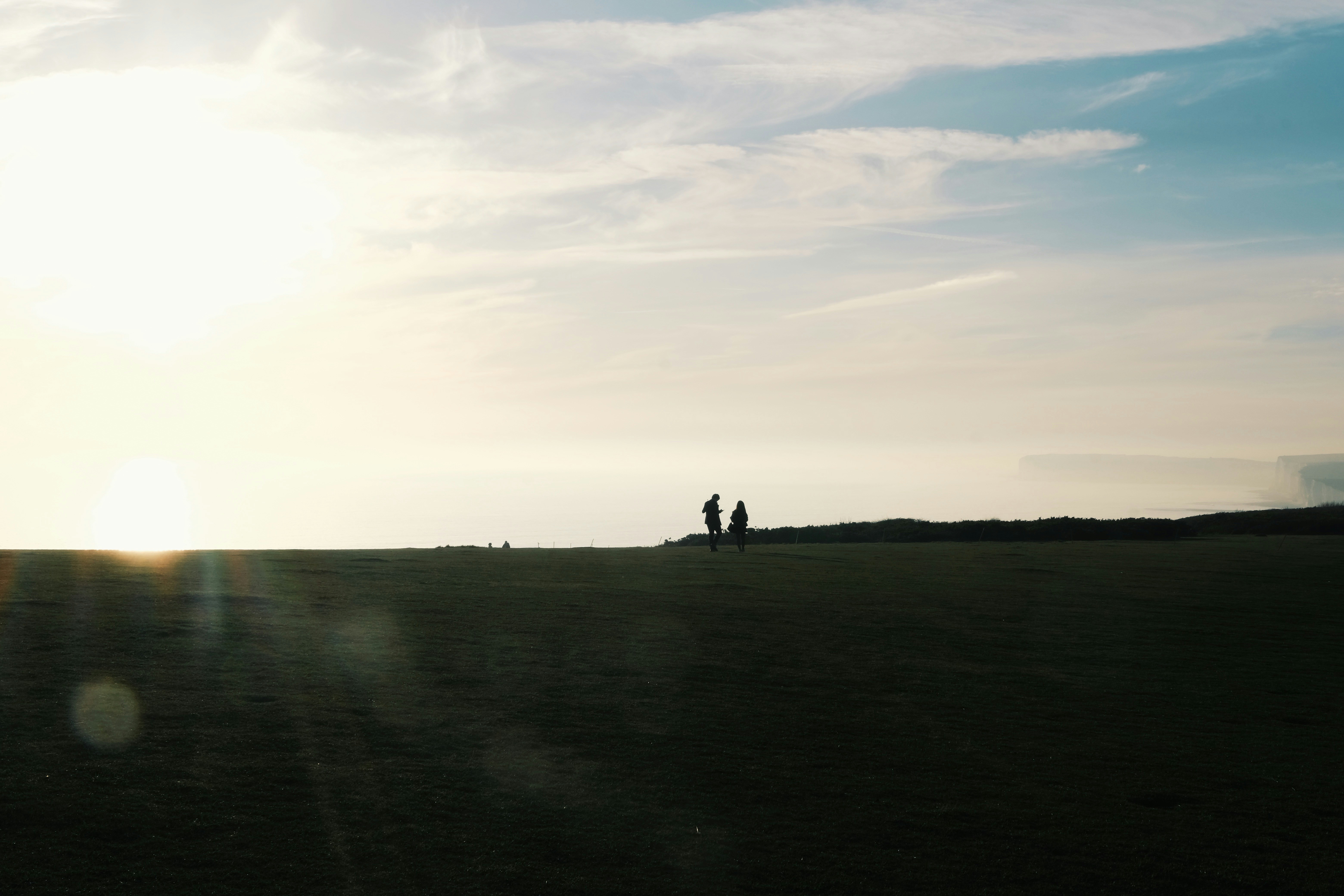 Silhouettes at the Crest: Two Figures on a Quiet Horizon