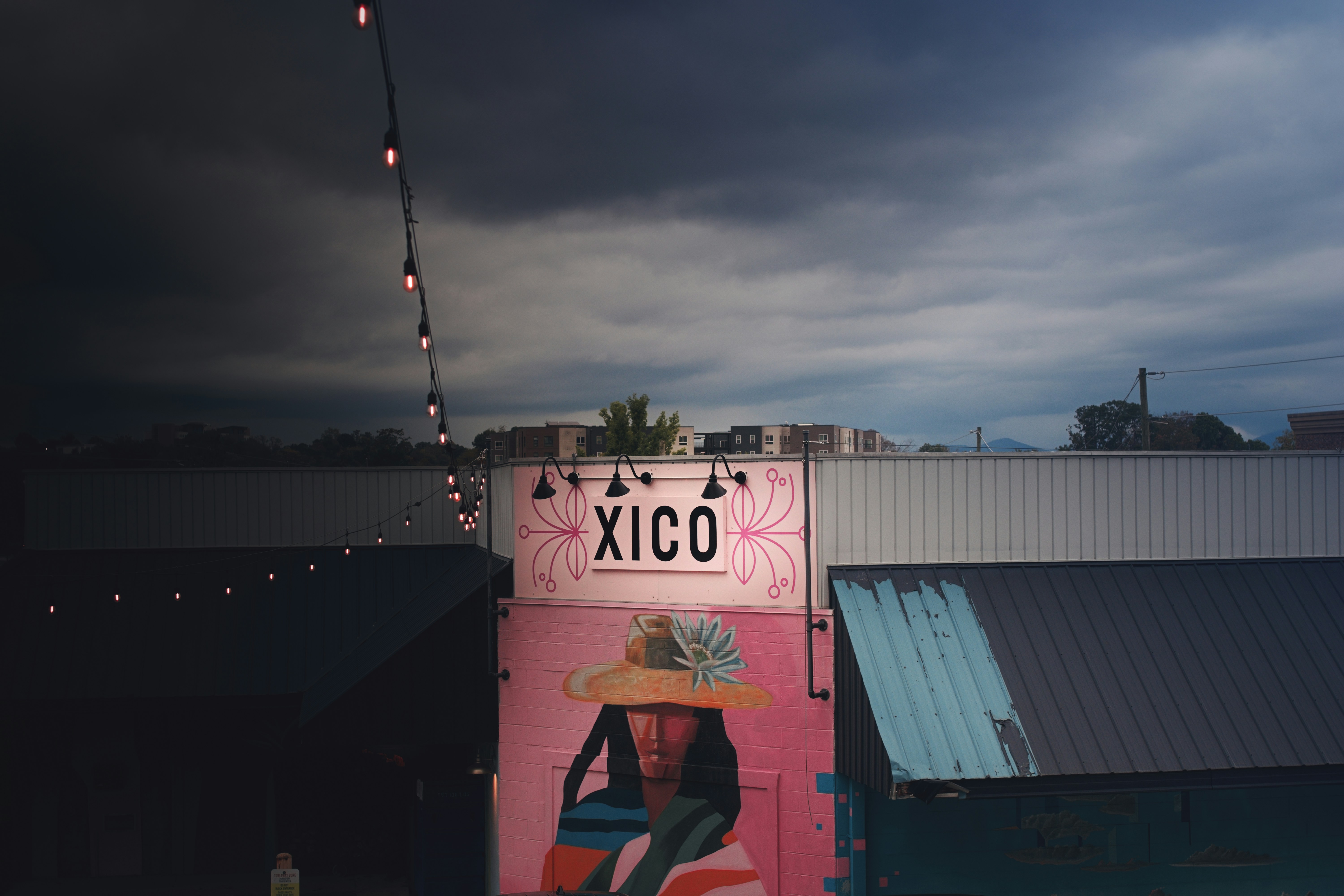 Muted Neon Twilight Over a Painted Wall Portrait