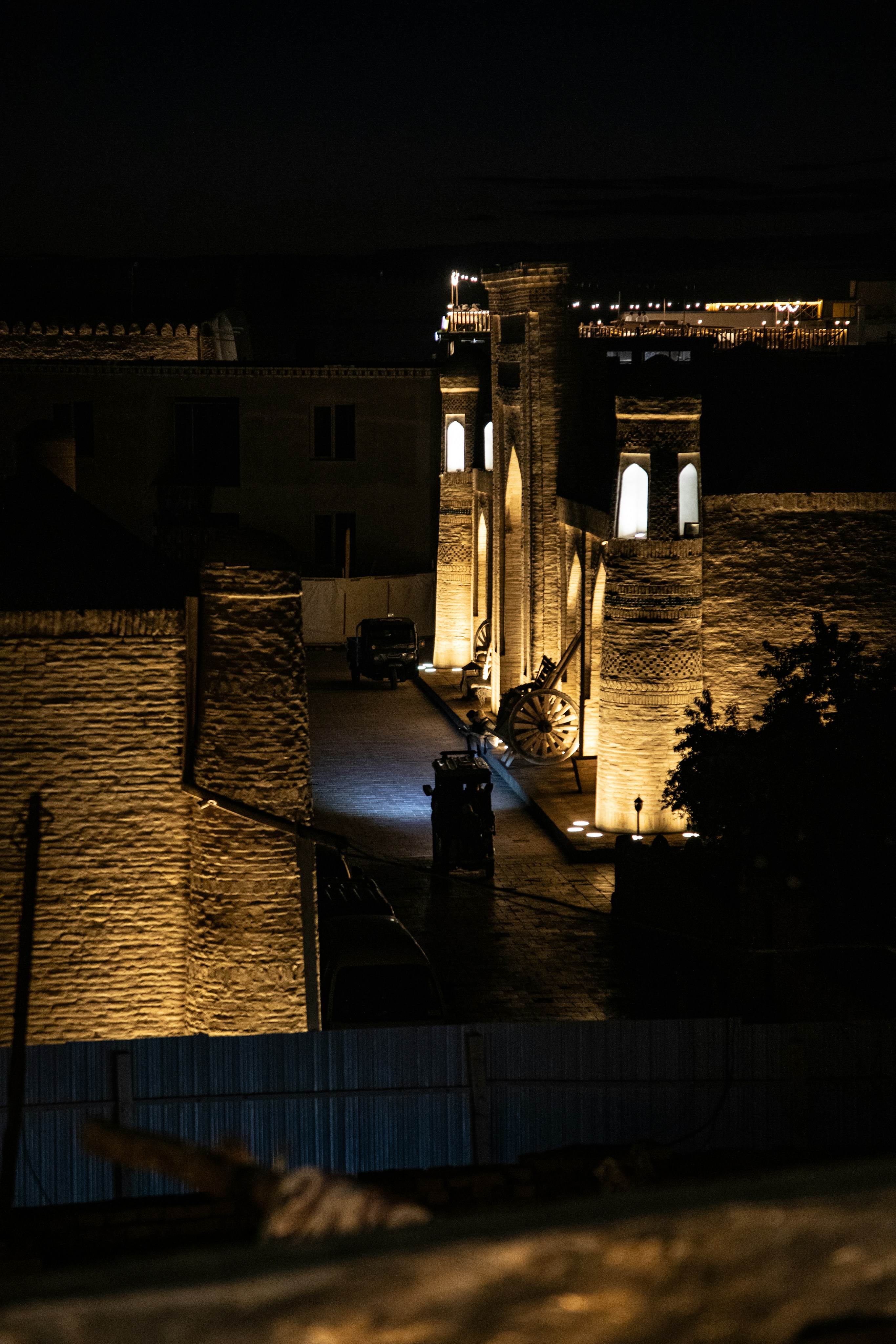 Moonlit Fortress: Illuminated Archways Guard a Quiet Street