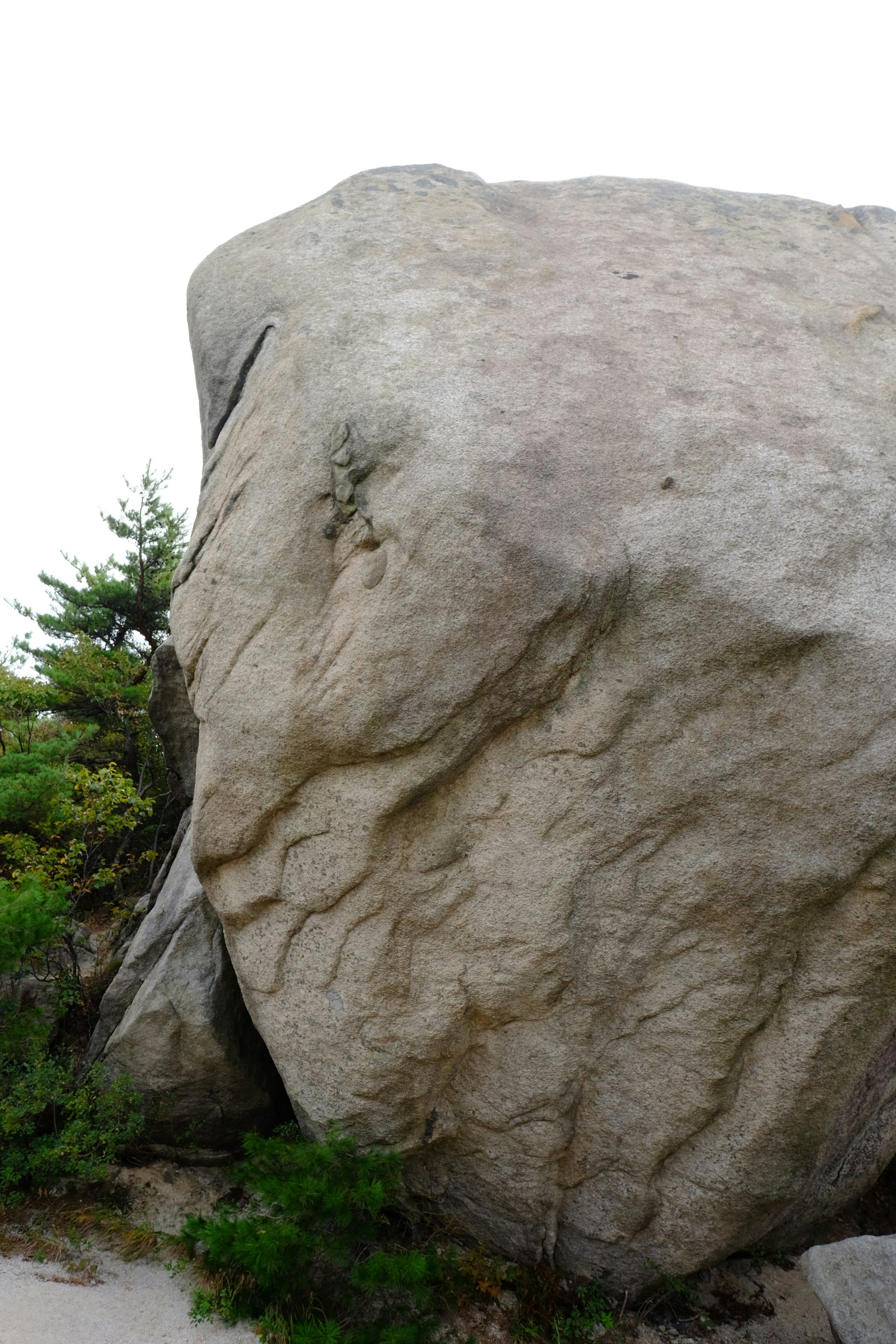 Granite Sentinel: A Weathered Monolith Dominating a Narrow Shore