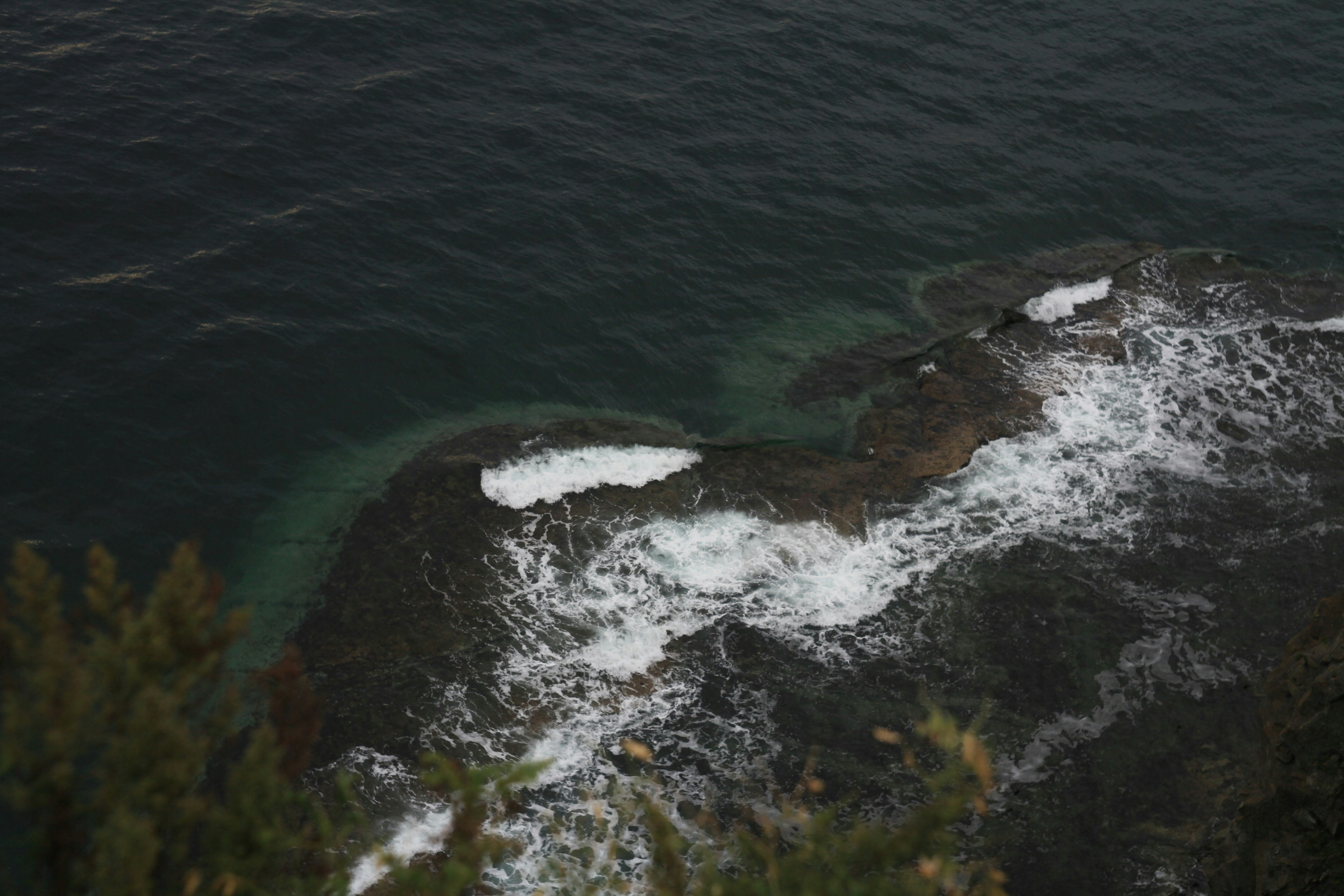 Emerald Tide Cleave: A Quiet Vortex Along Cloud-Washed Rocks