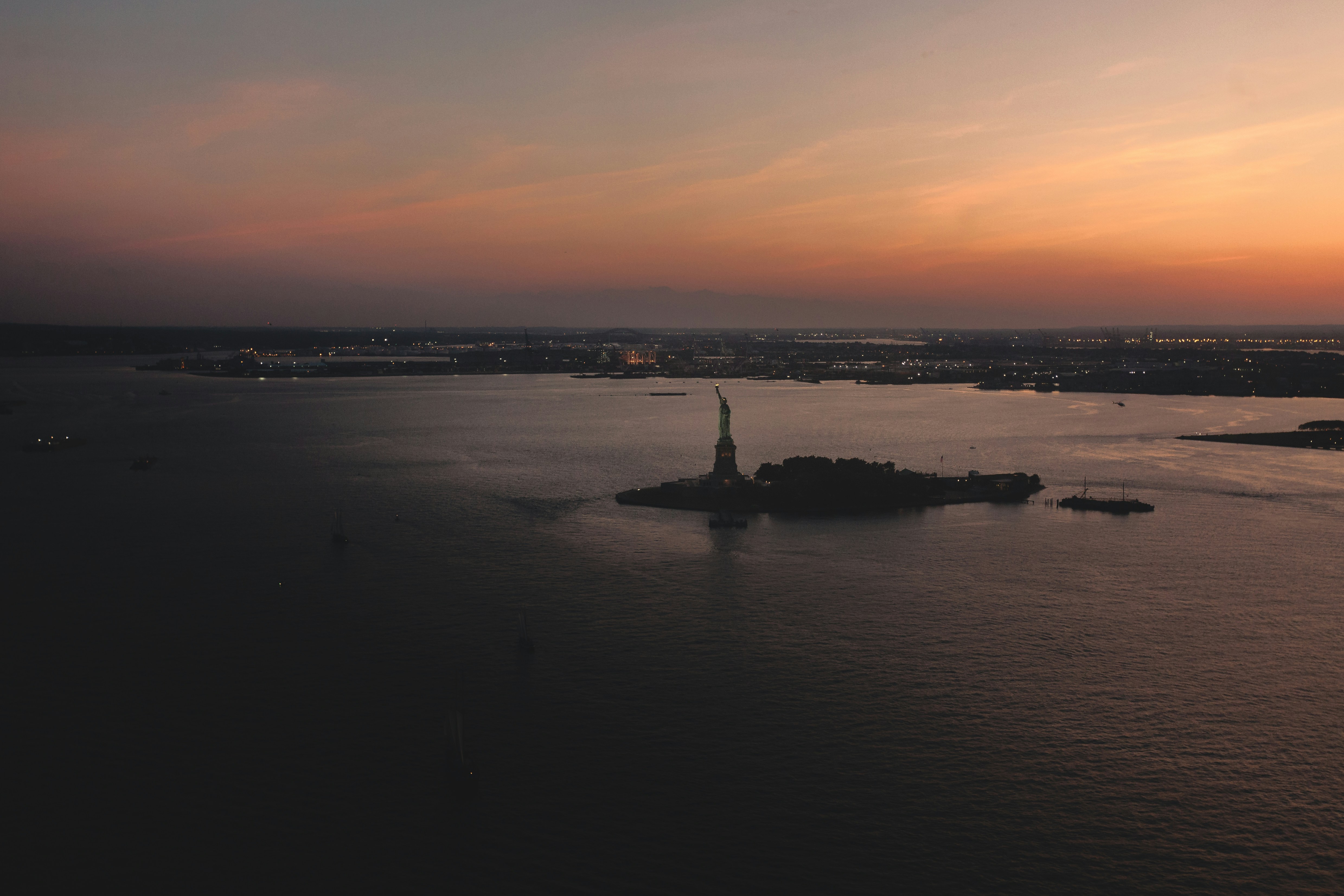 Distant Harbor at Dusk: The Statue of Liberty on a Quiet Island