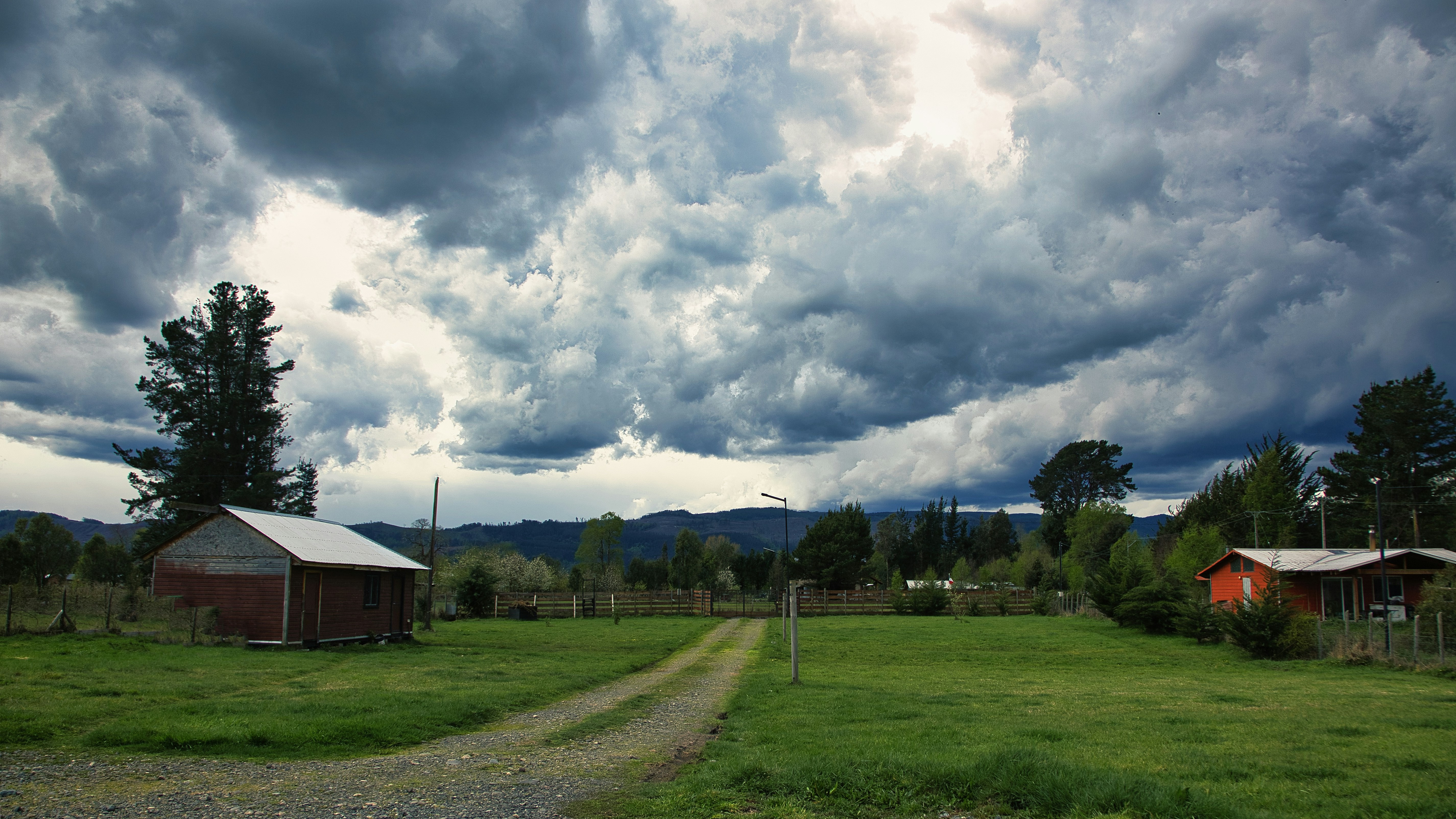 Rural Roadway Toward a Storm-Worn Horizon