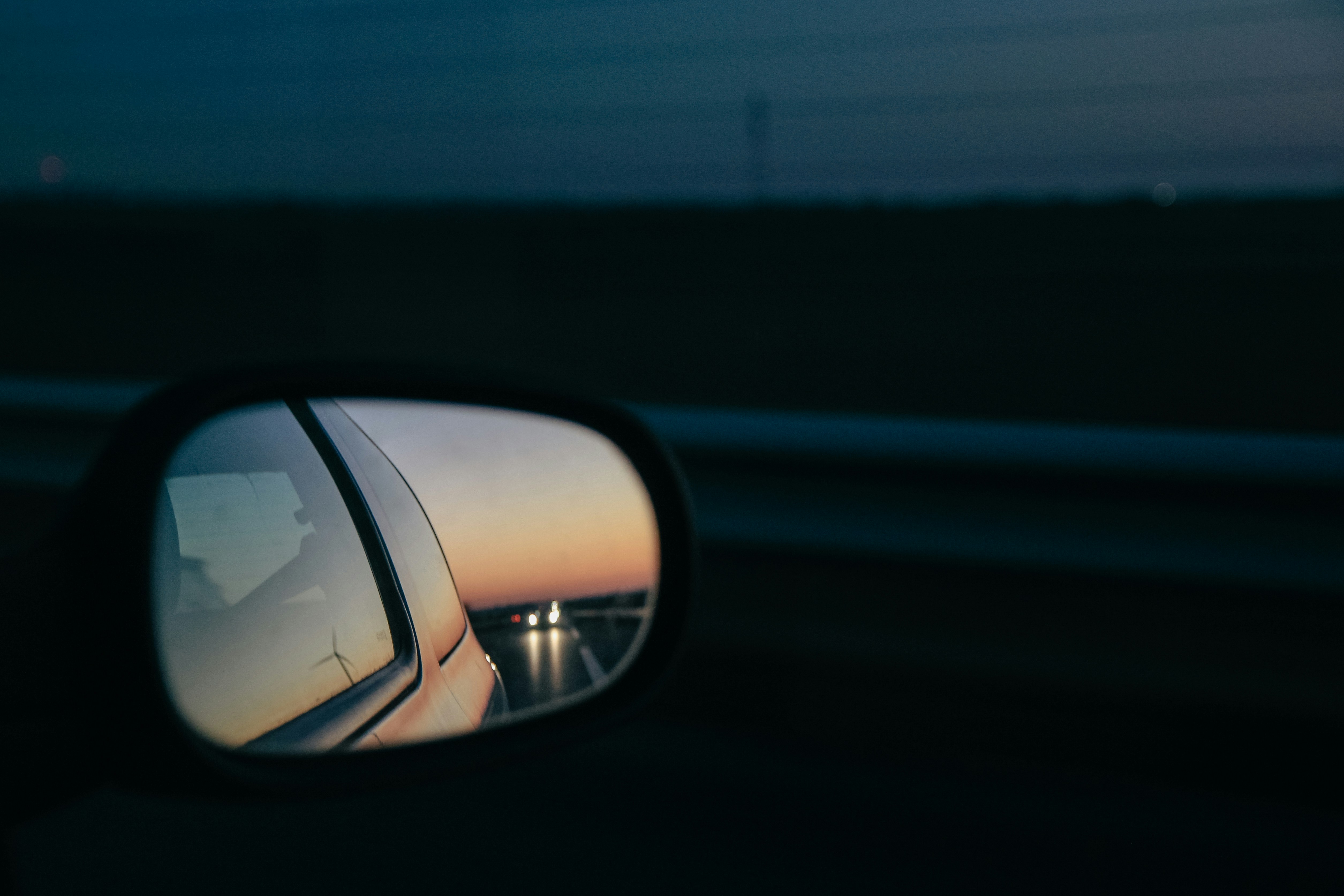 Rear-View Horizon: Sunset Reflection in a Moving Mirror