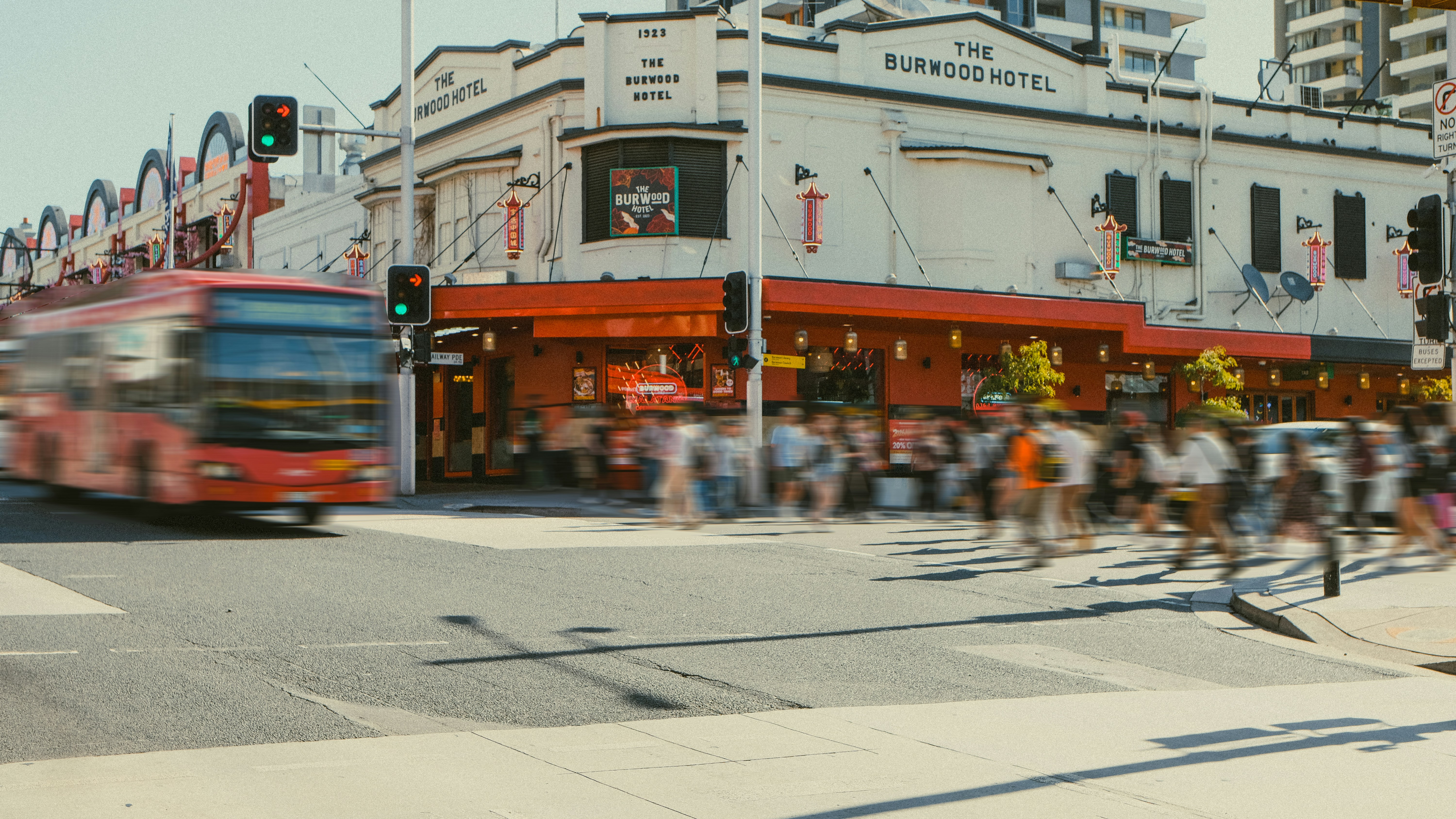 Urban Crossroads: Blurred Pedestrians in Front of a Classic Hotel