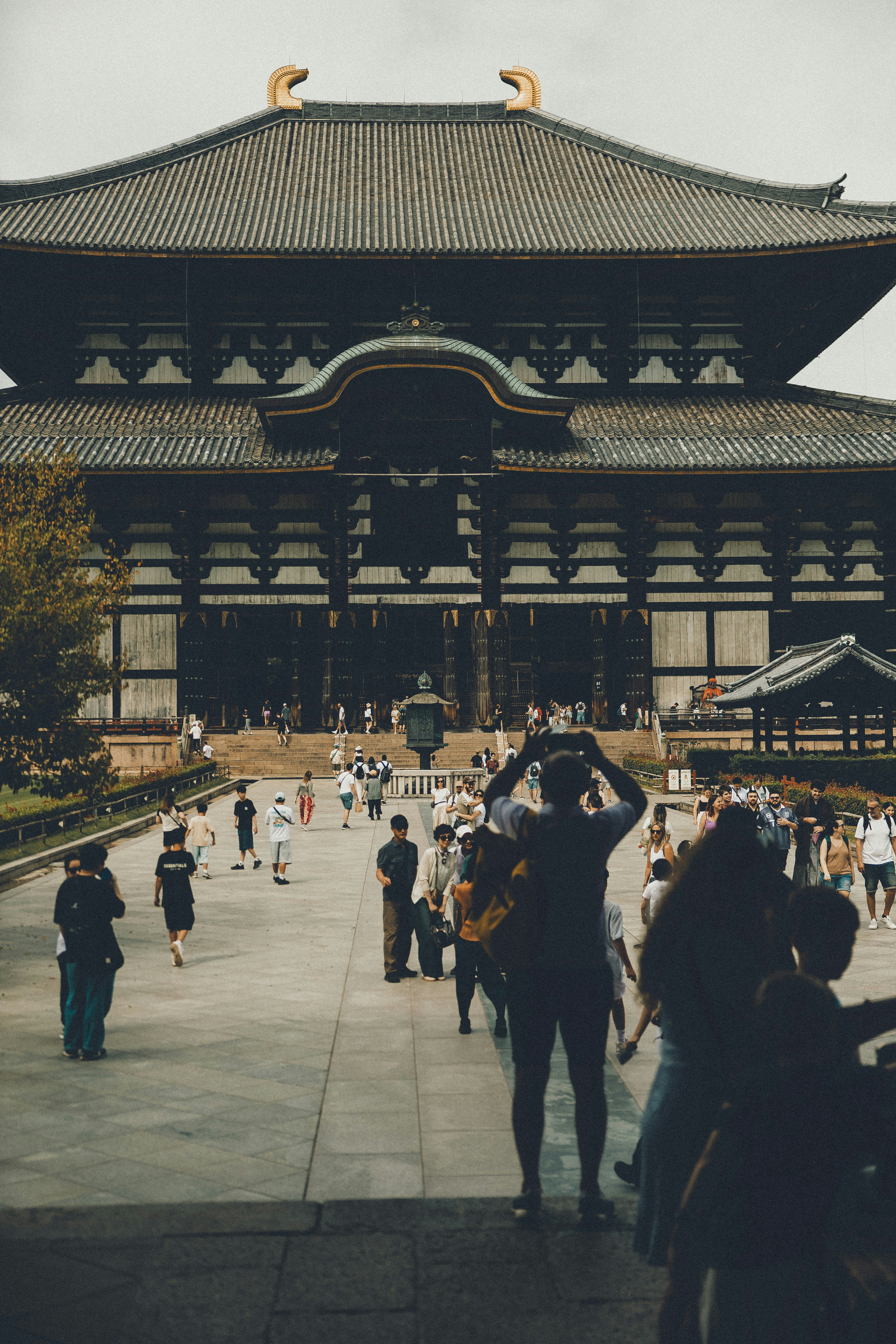 Coastal Gate: Visitors Entering a Majestic Temple Courtyard