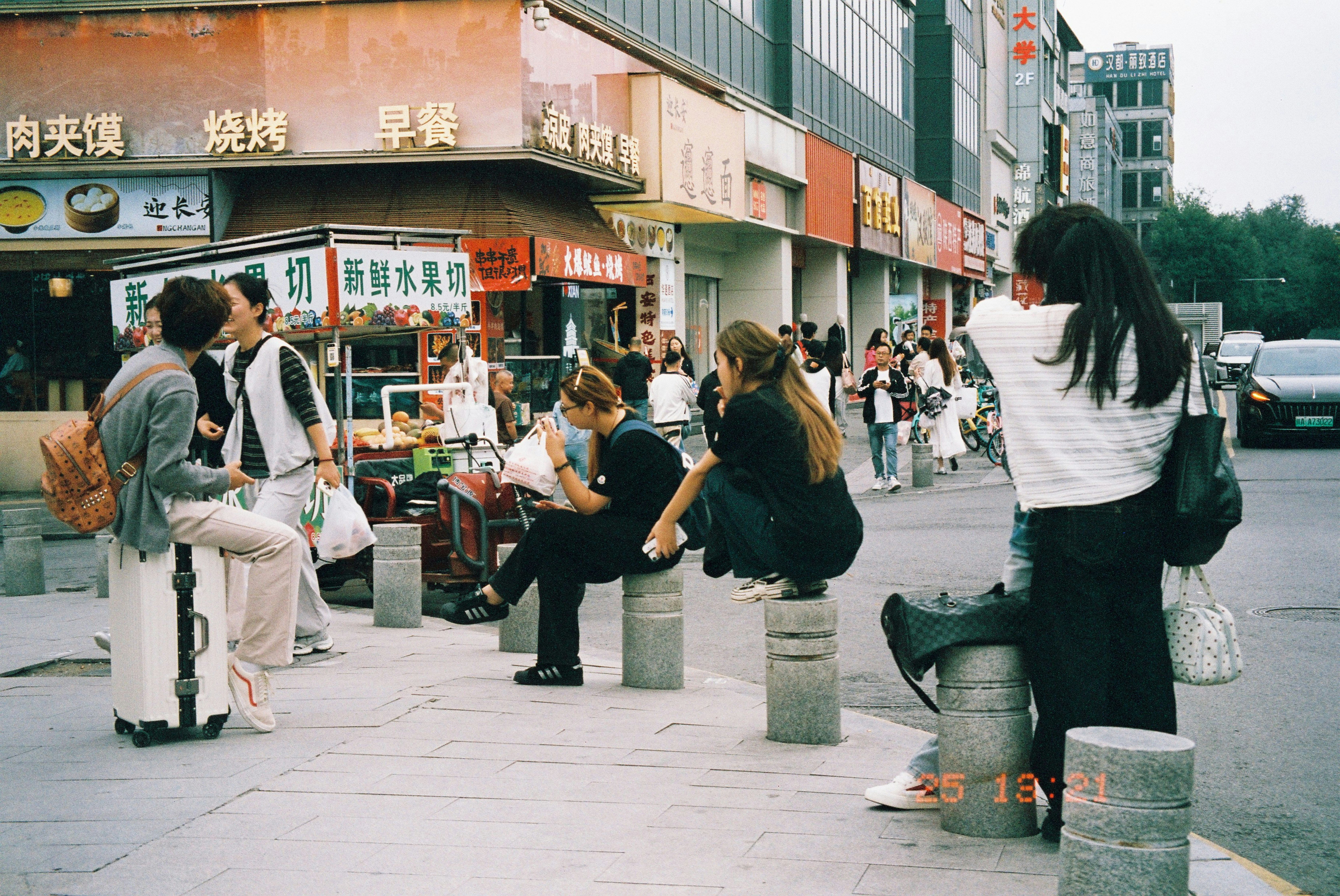 Urban Pause: Friends and Passersby on a Busier Chinese Street