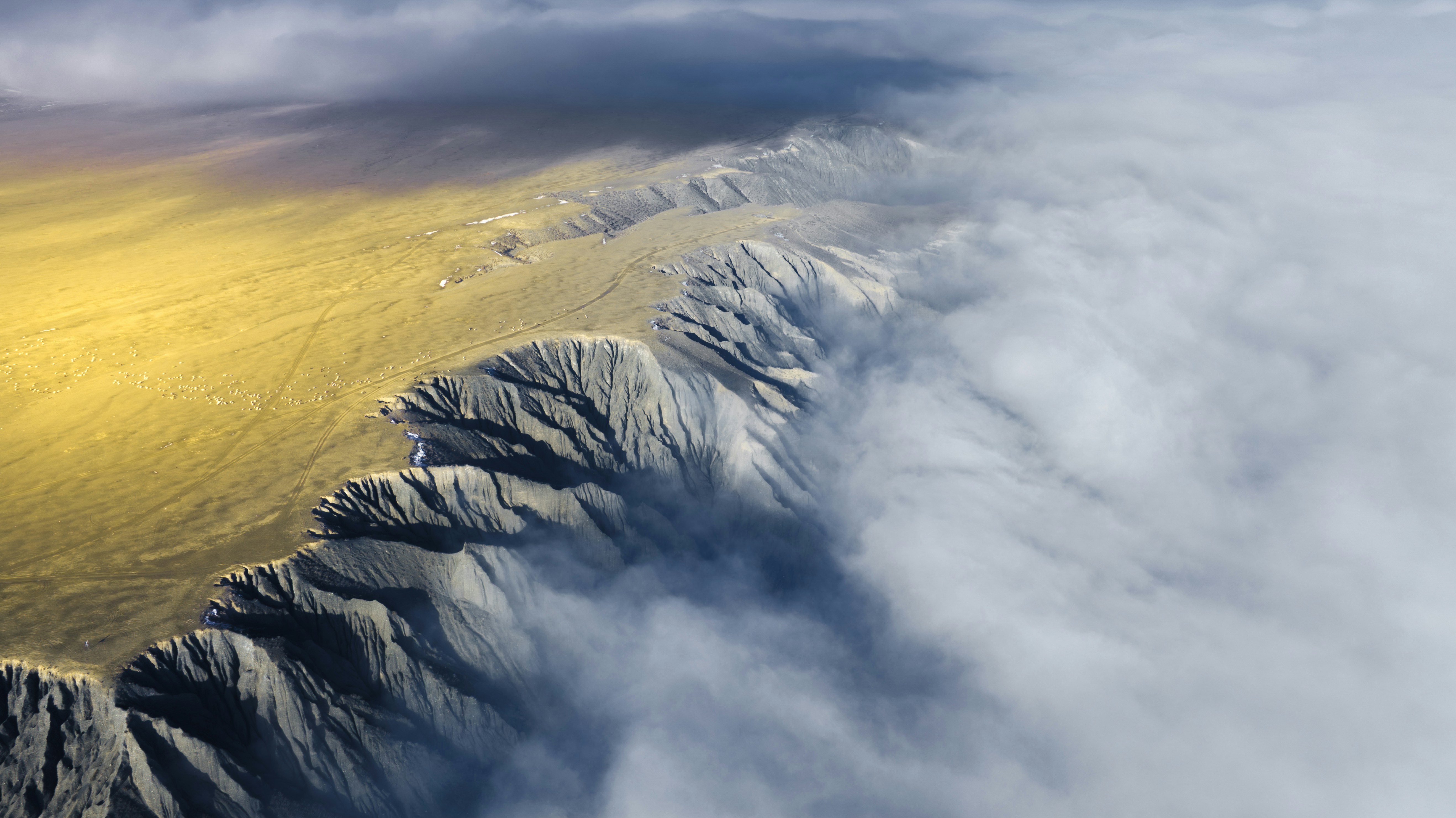 Golden Ridge: Aerial Dawn Over Rugged Canyon Frontiers