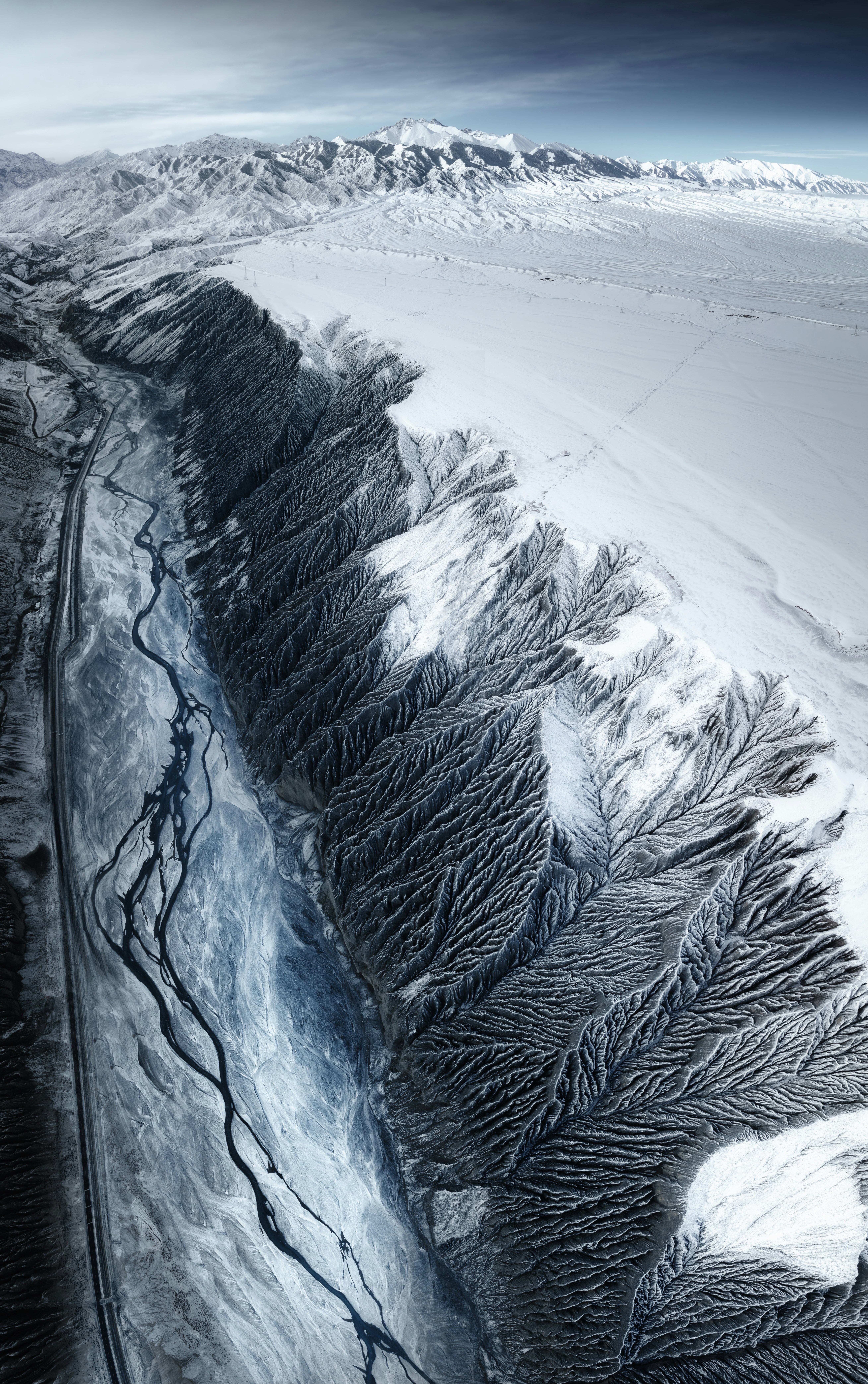 Ridge and Glacier: A Frozen Spine Sliced by a Dark Highway