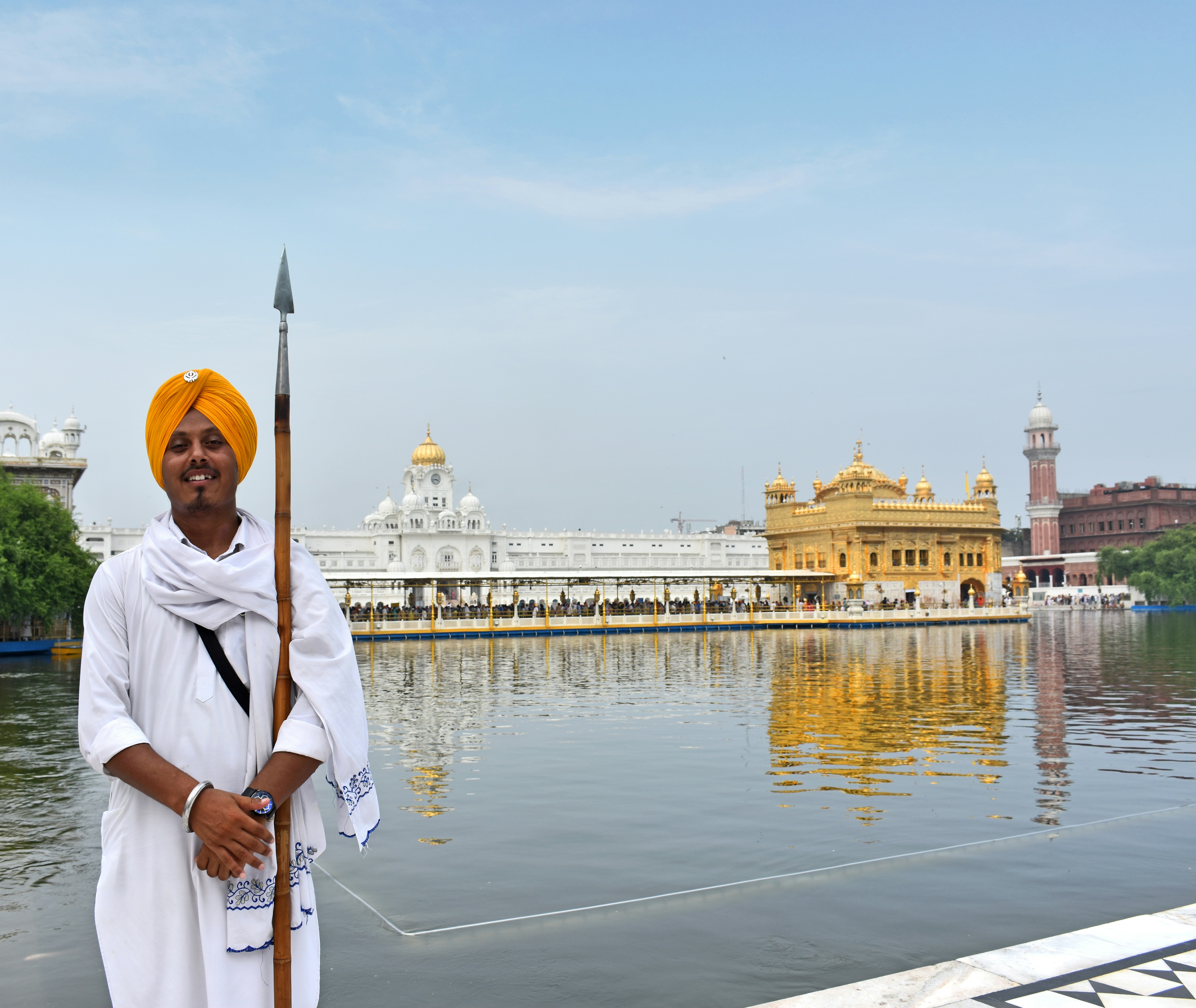 Guard at the Golden Temple Complex, early morning stillness by the sacred pool