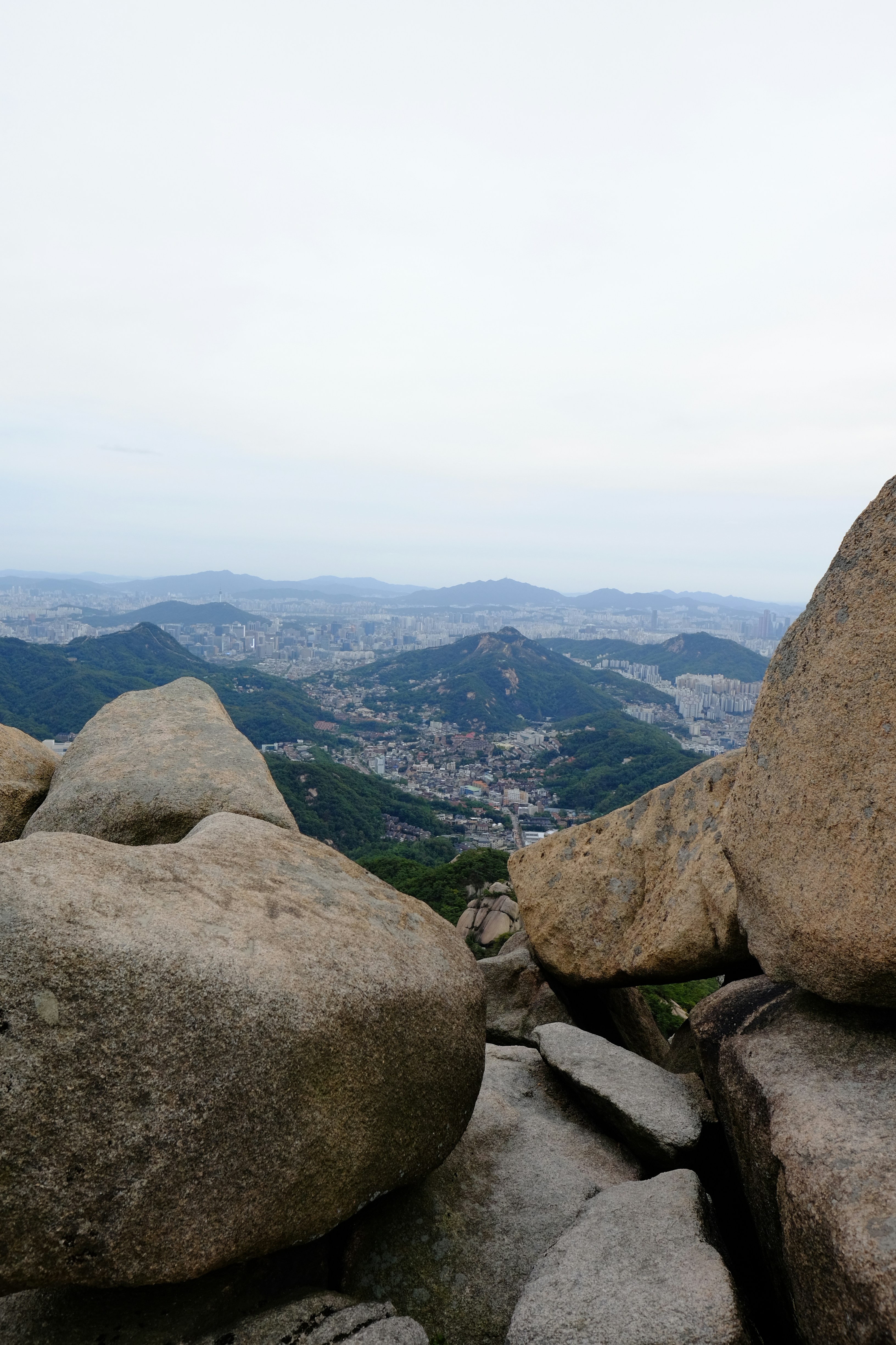 Boulder Gate to the City: A Rock-Shoot Vista Over the Valley