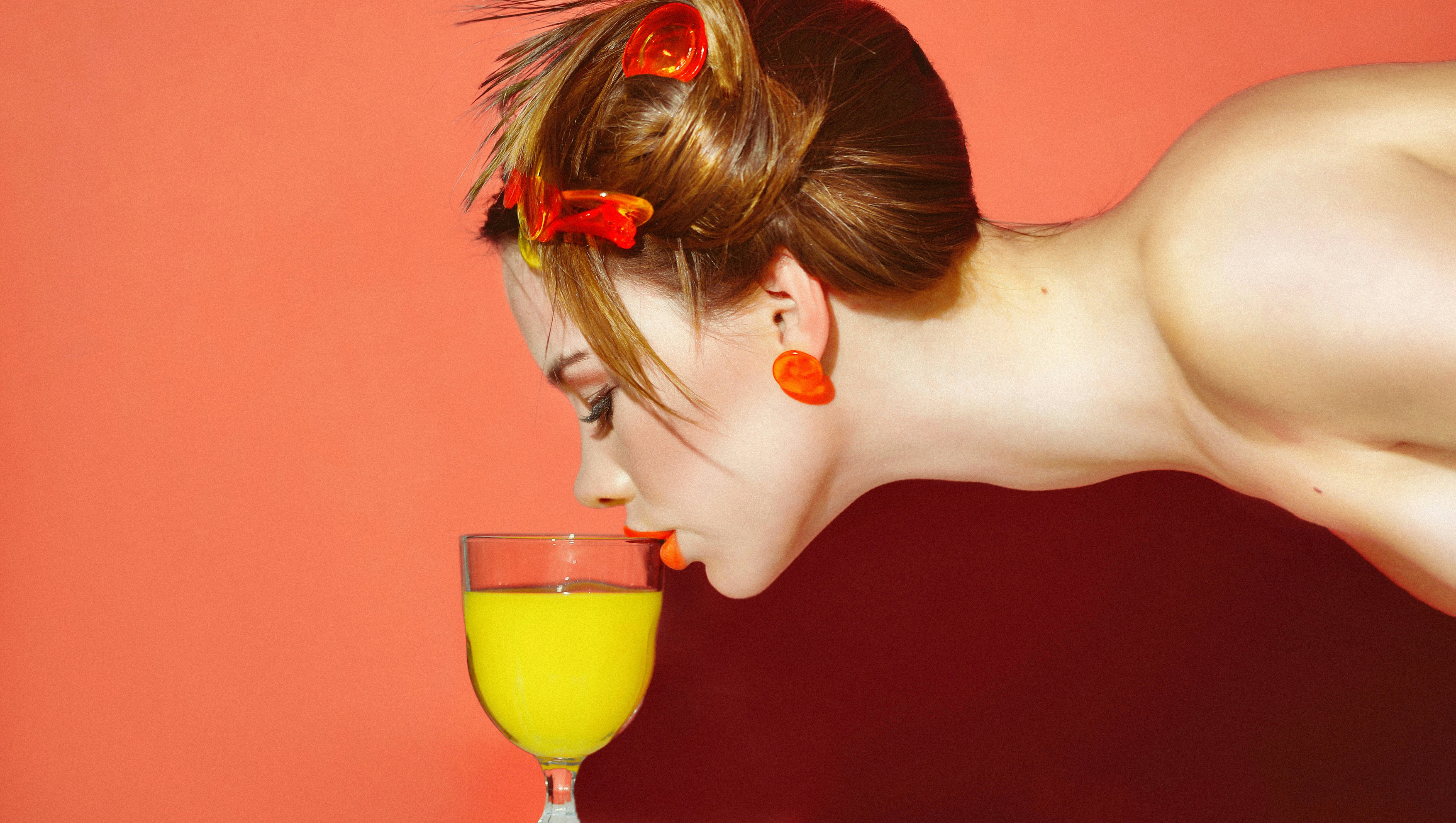 Curved Gaze: A Precise Sip from a Citrus Glow
