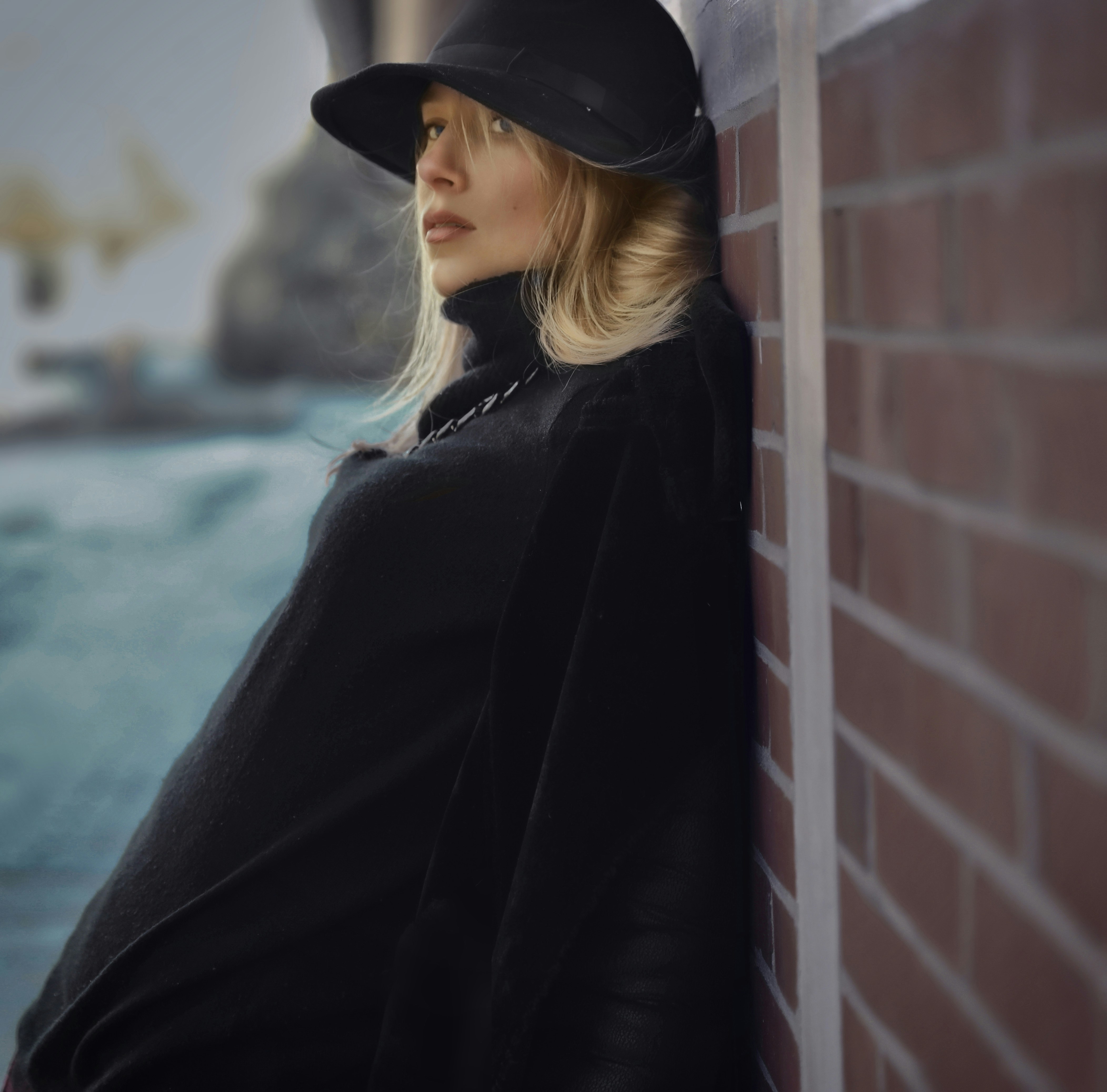 Overcast in Velvet Black: A Portrait by the Wall
