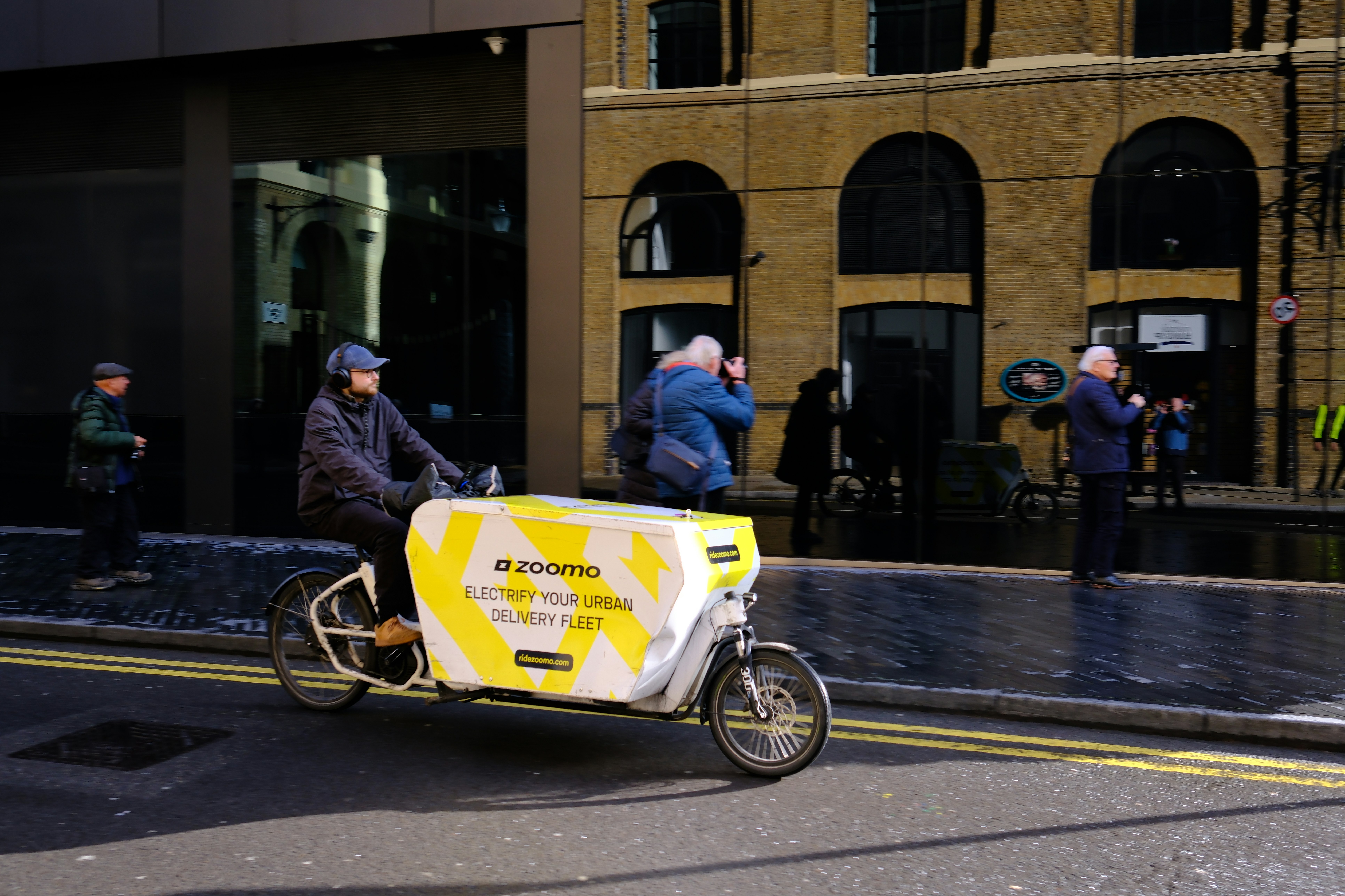 Pedal-Powered Courier in a Busy Urban Street