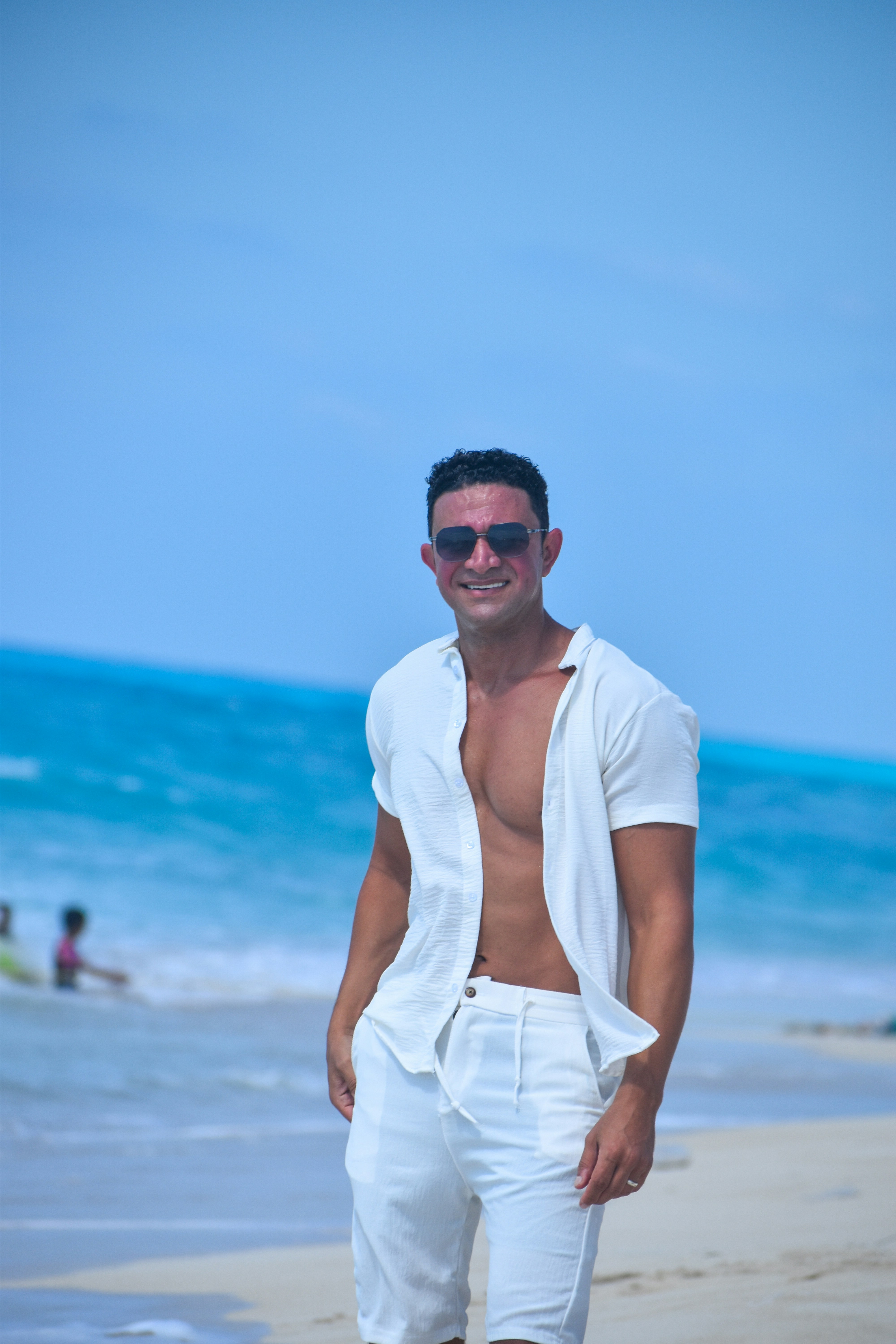 Sunlit Confidence: A Seaside Portrait in White