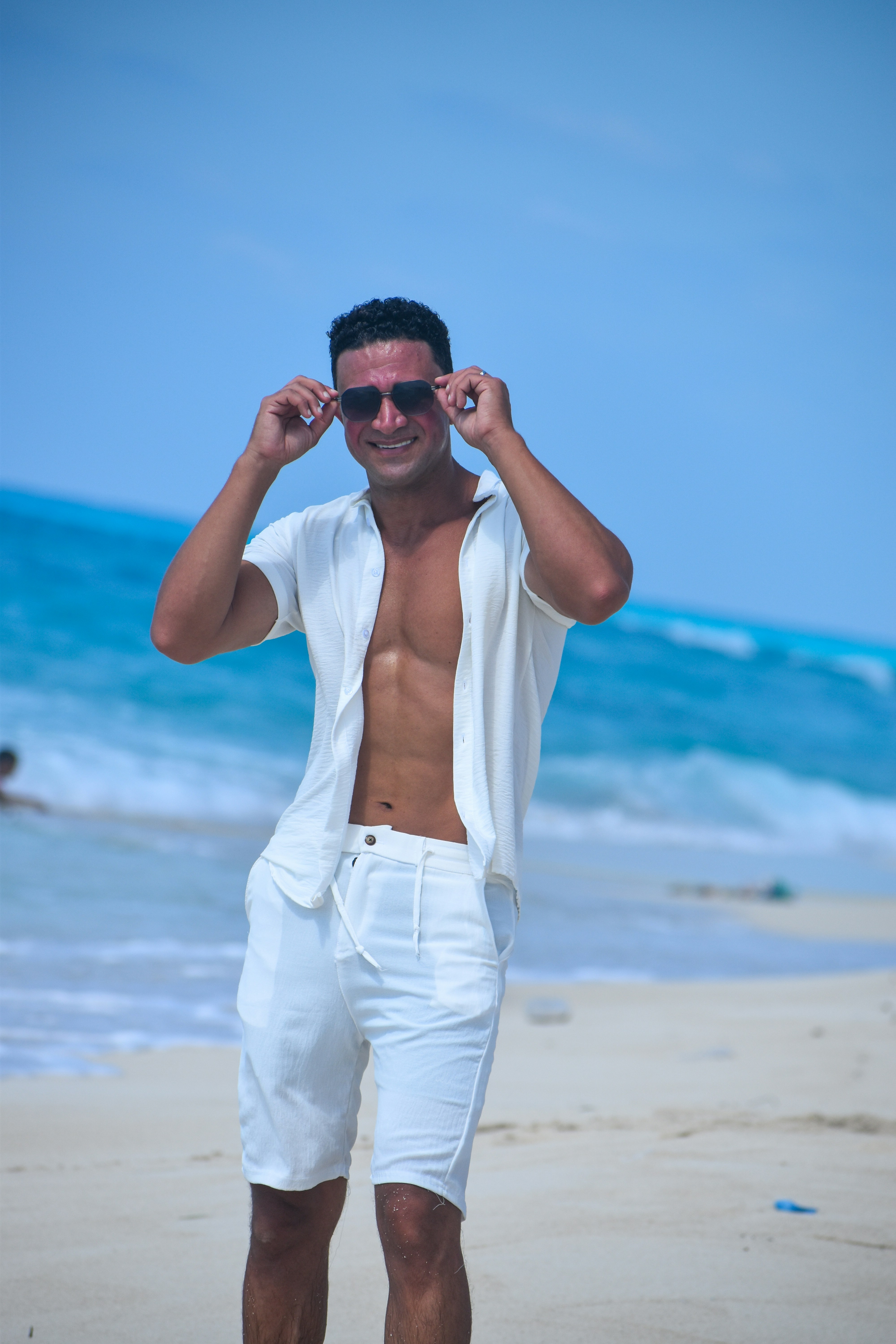 Sunlit Confidence: A Shoreline Stroll in White on White