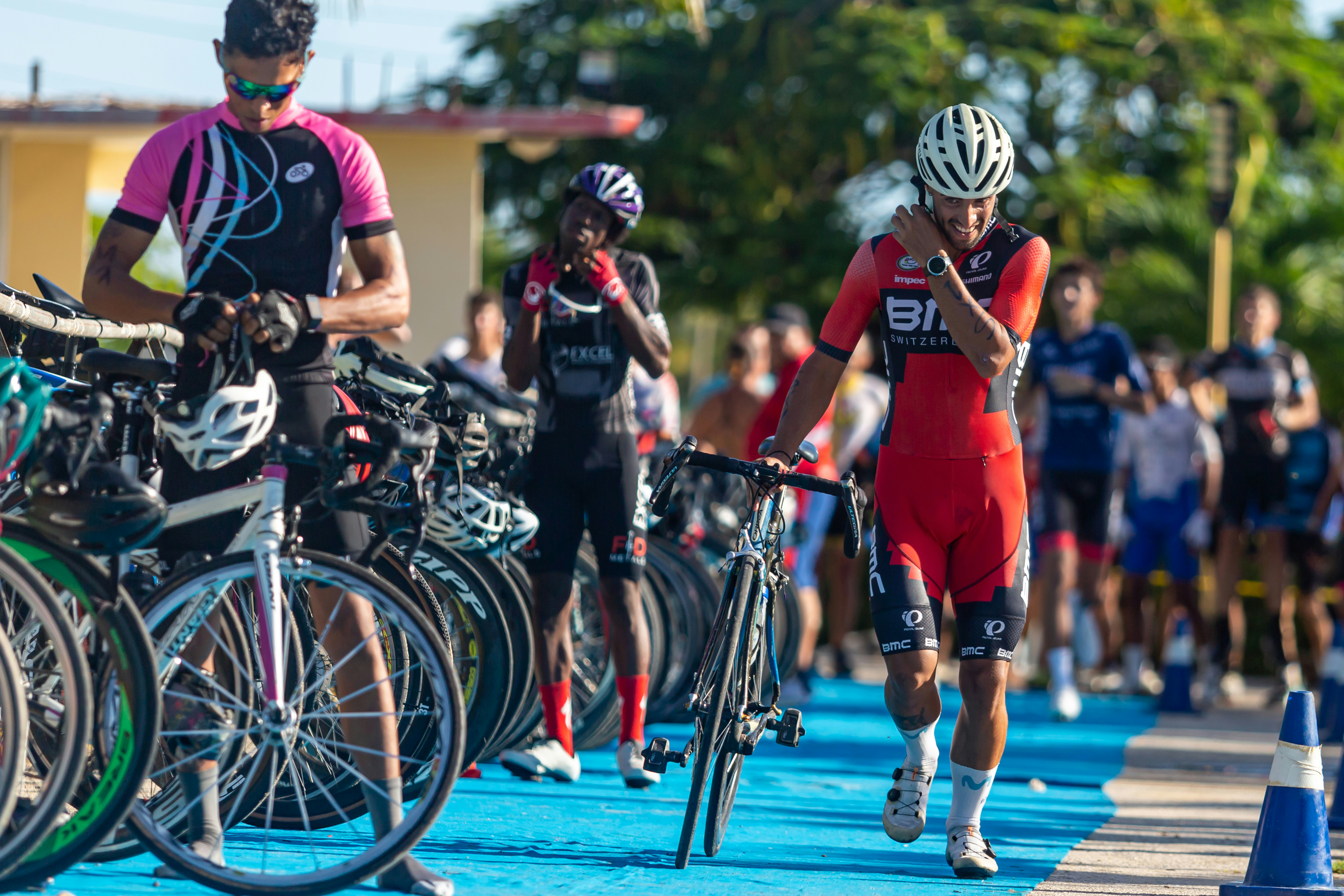Race Start: Cyclists in a Blue-Carpeted Paddock Prepare for the Line