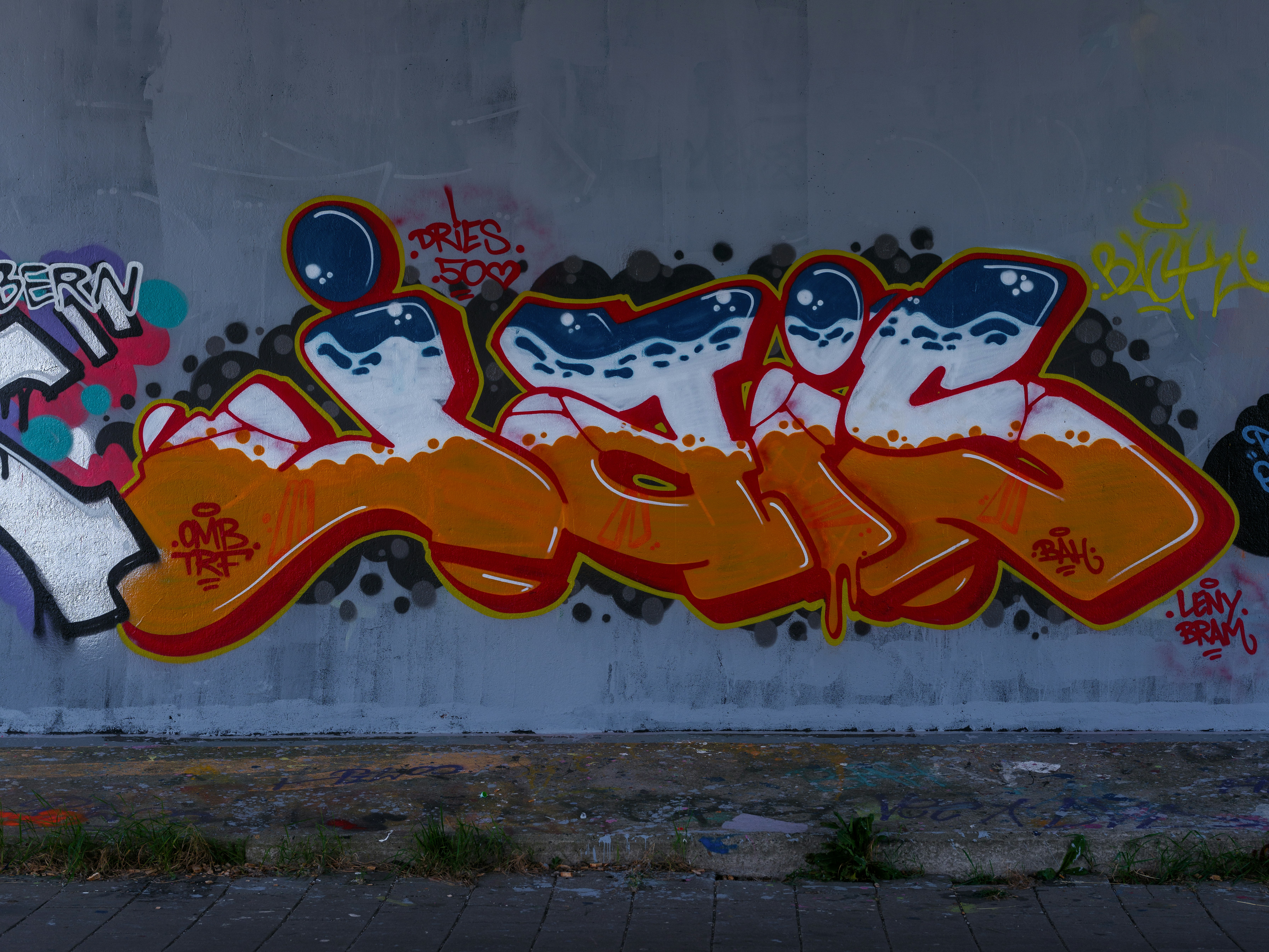 Vivid Graffiti Fragment: Orange Blue Outline on Concrete