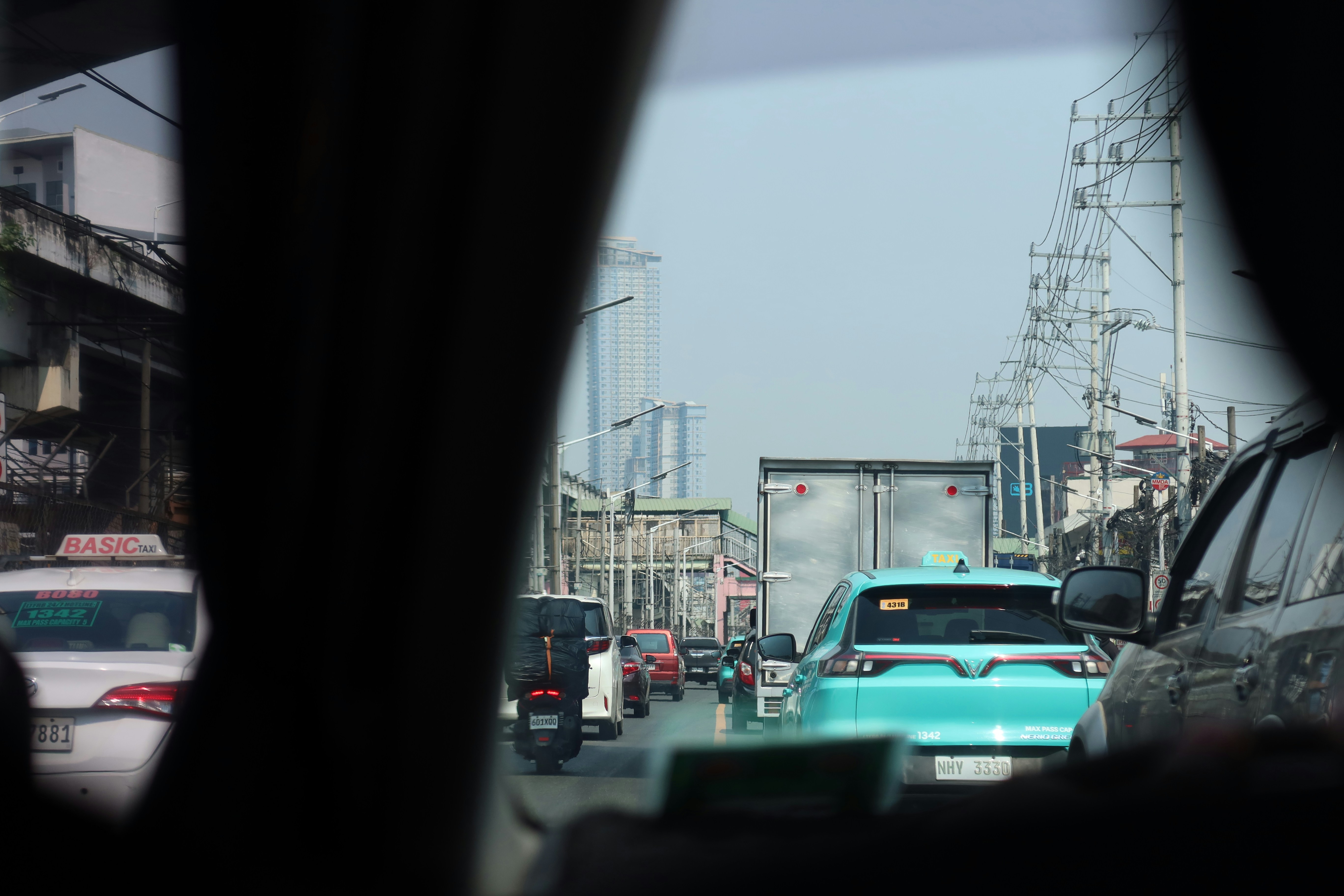 Through the Back Window: City Traffic Framed by Dark Curtains