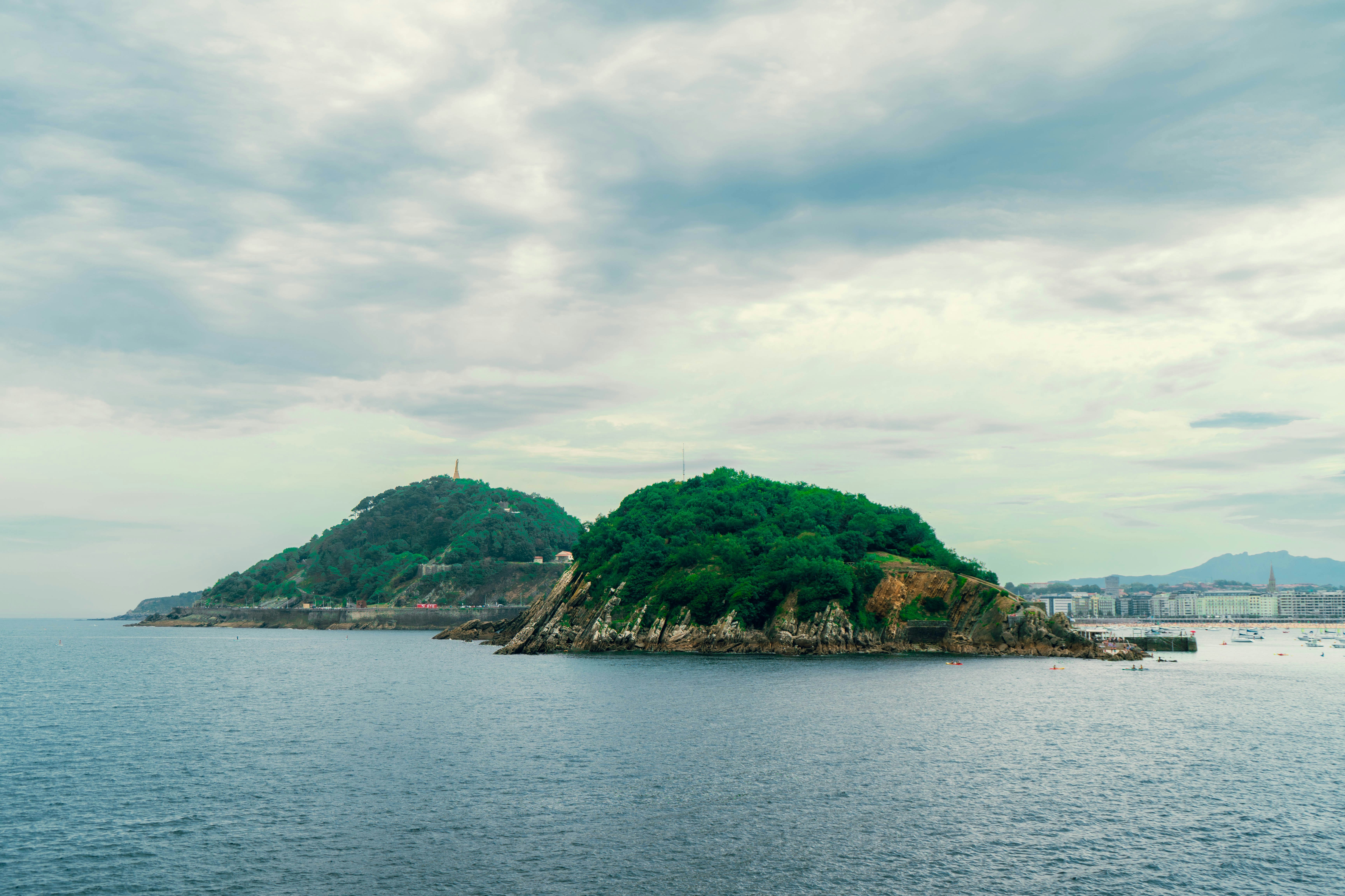 Island Sanctuary Crest: Green Hill Beneath a Wide Sky