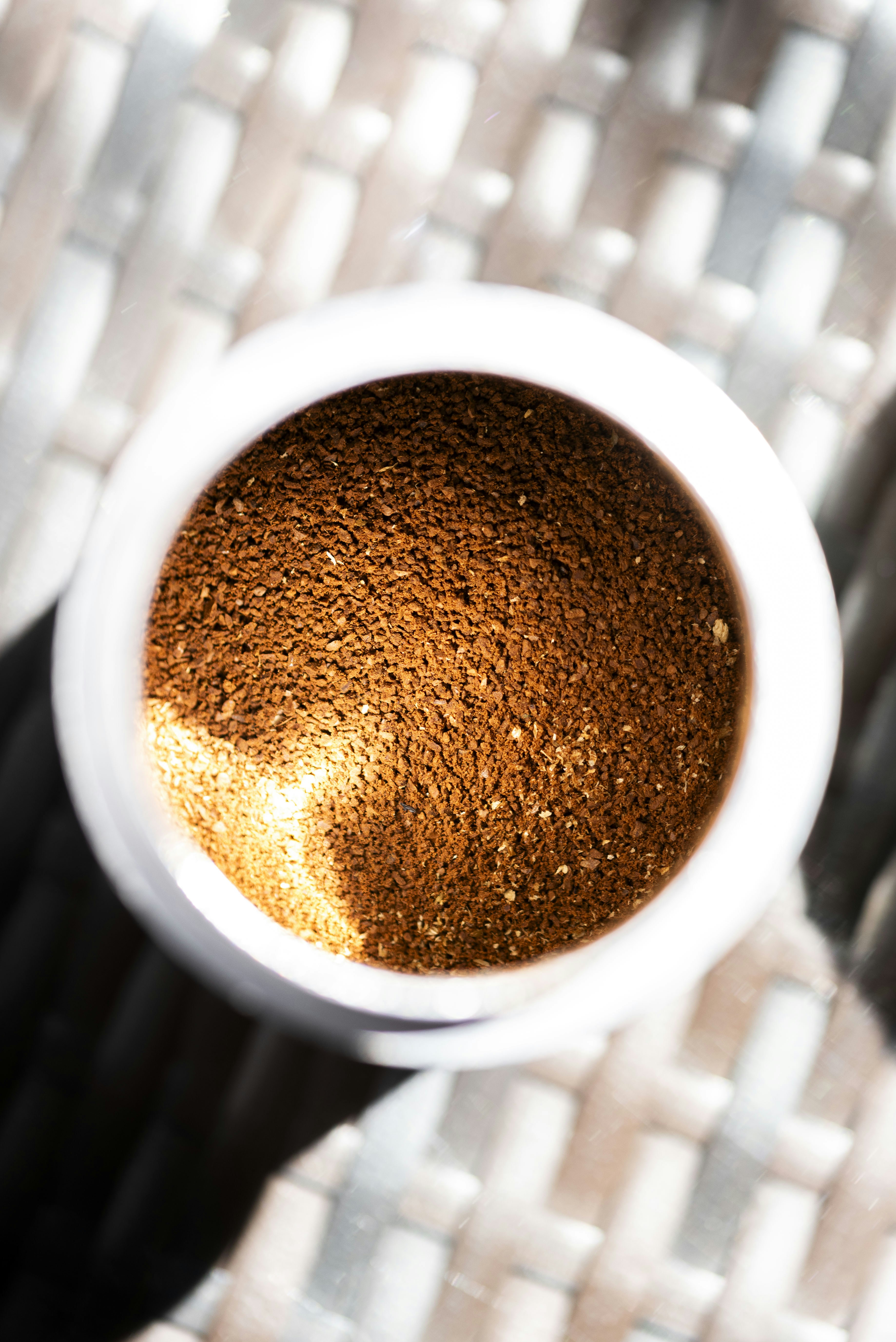 Top-Down Espresso Grounding: Coffee Grounds in a White Cup