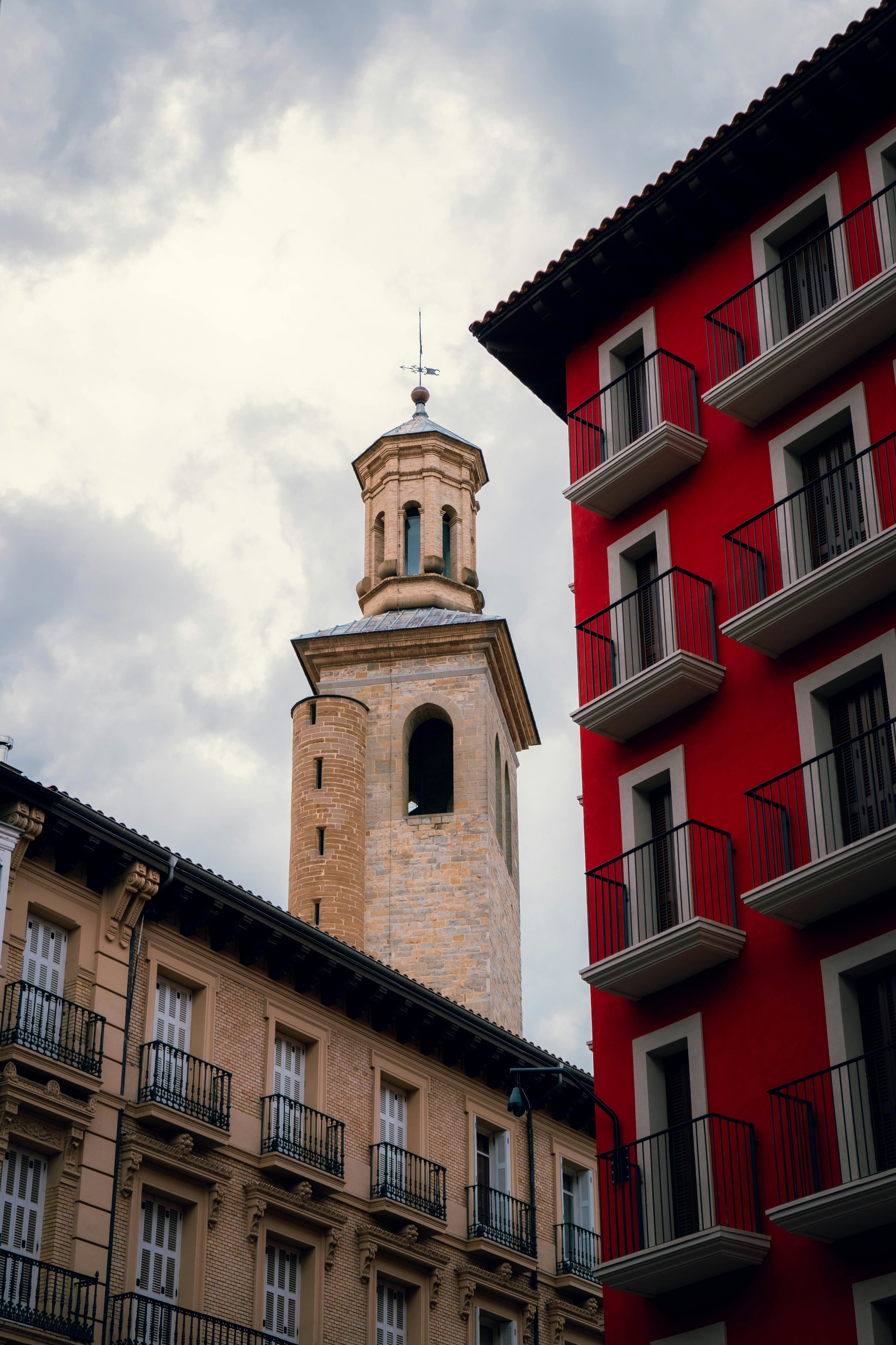 Urban Bell Tower Between Echoing Facades