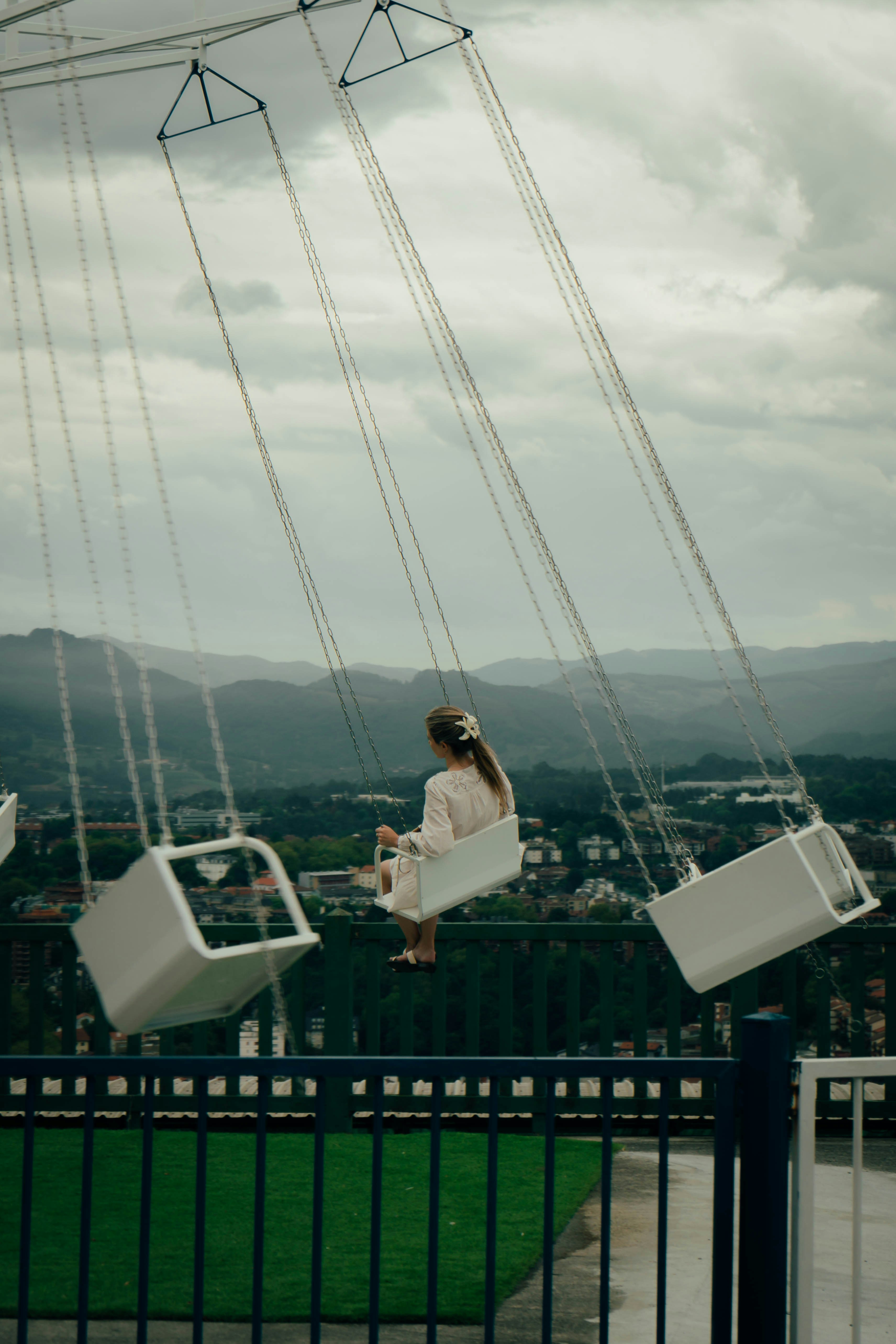 Swinging Above the City: A Quiet Moment on the Ferris Sky