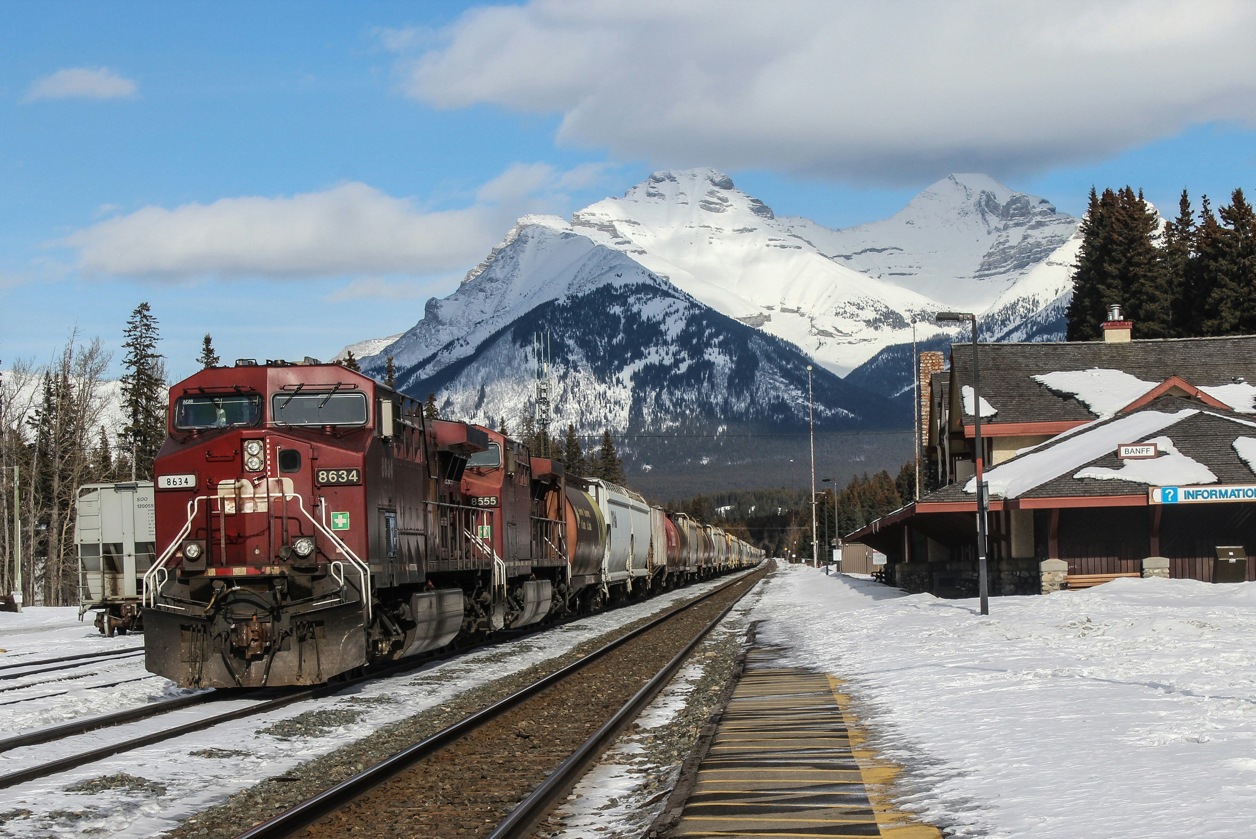 Snowbound Rails: A Red Locomotive Leading the Quiet Mountain Line