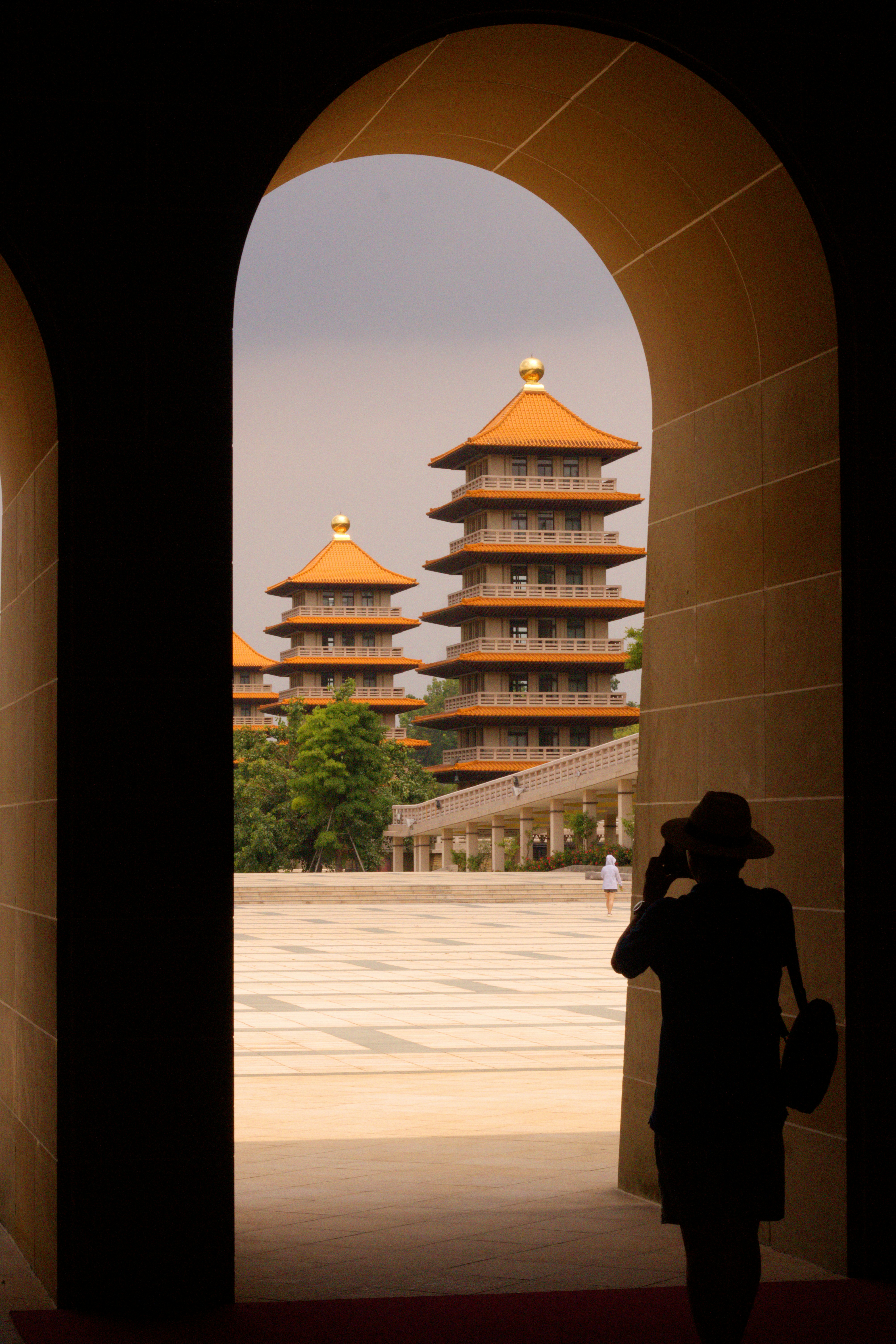 Gateway to the Pagodas: Shadowed Visitor at the Arch