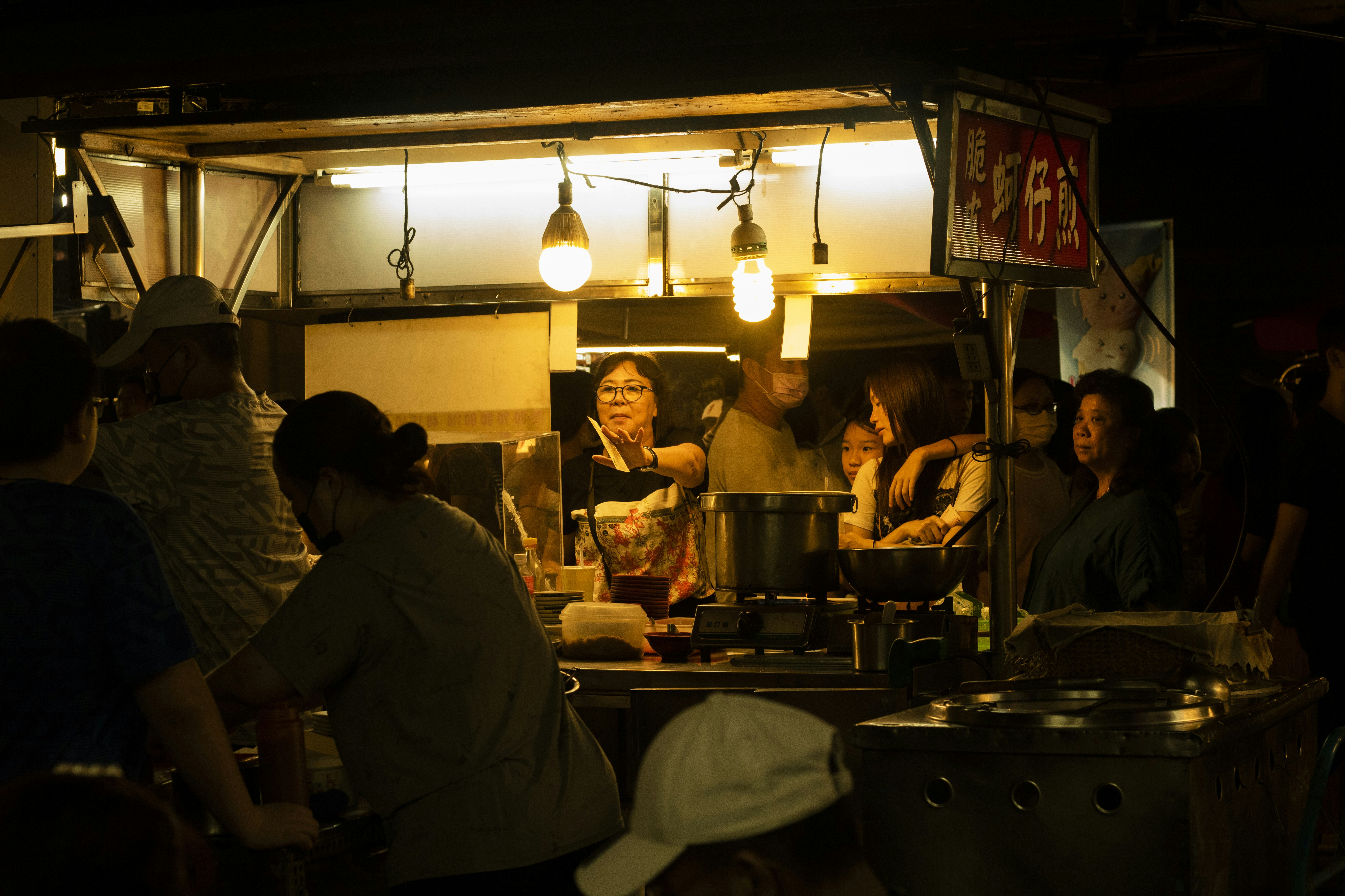Warm Lanterns and Steam: Night Grill Stand Portrait