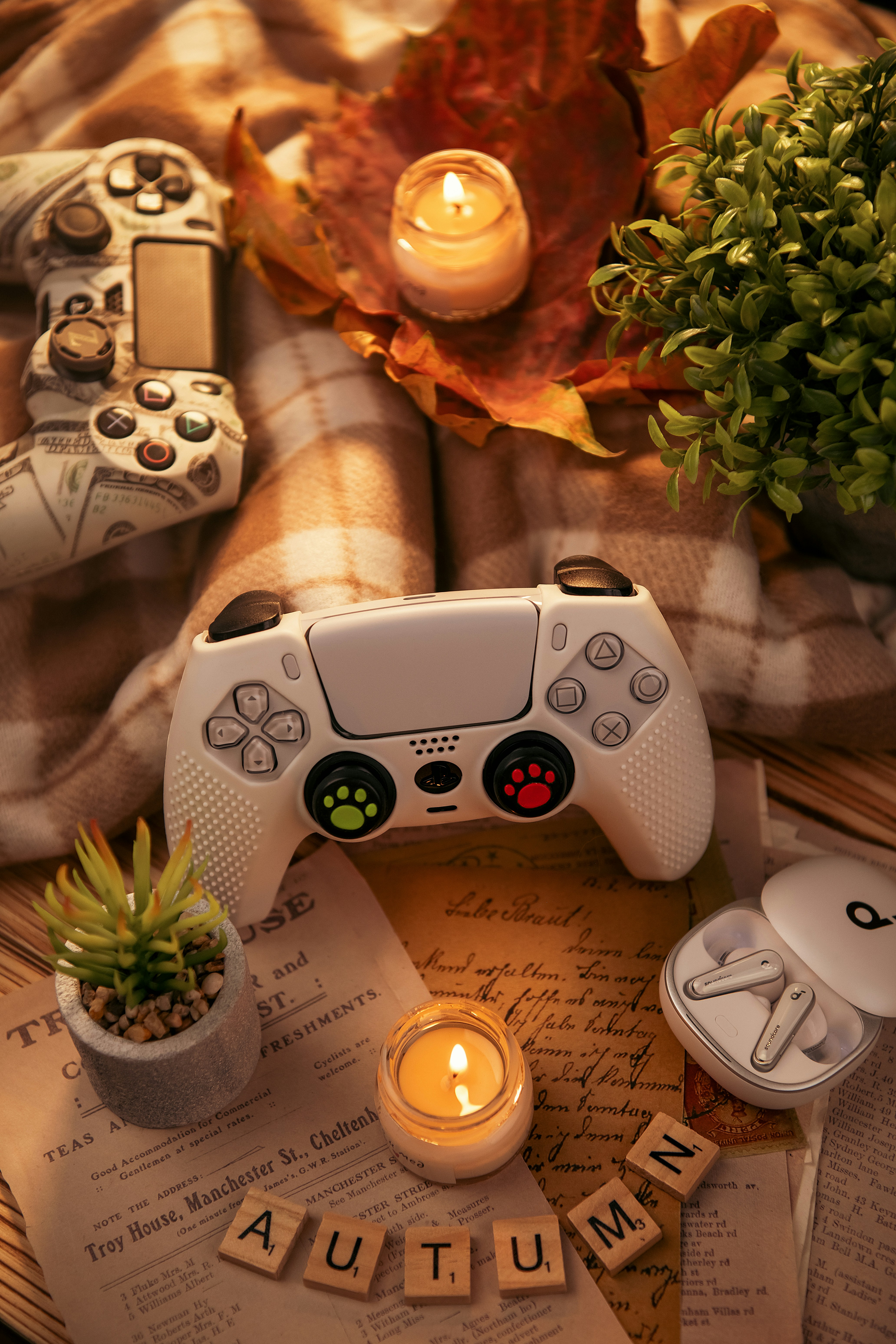 Autumn Glow: A Cozy Console with Gamepads, Candles, and Leaves