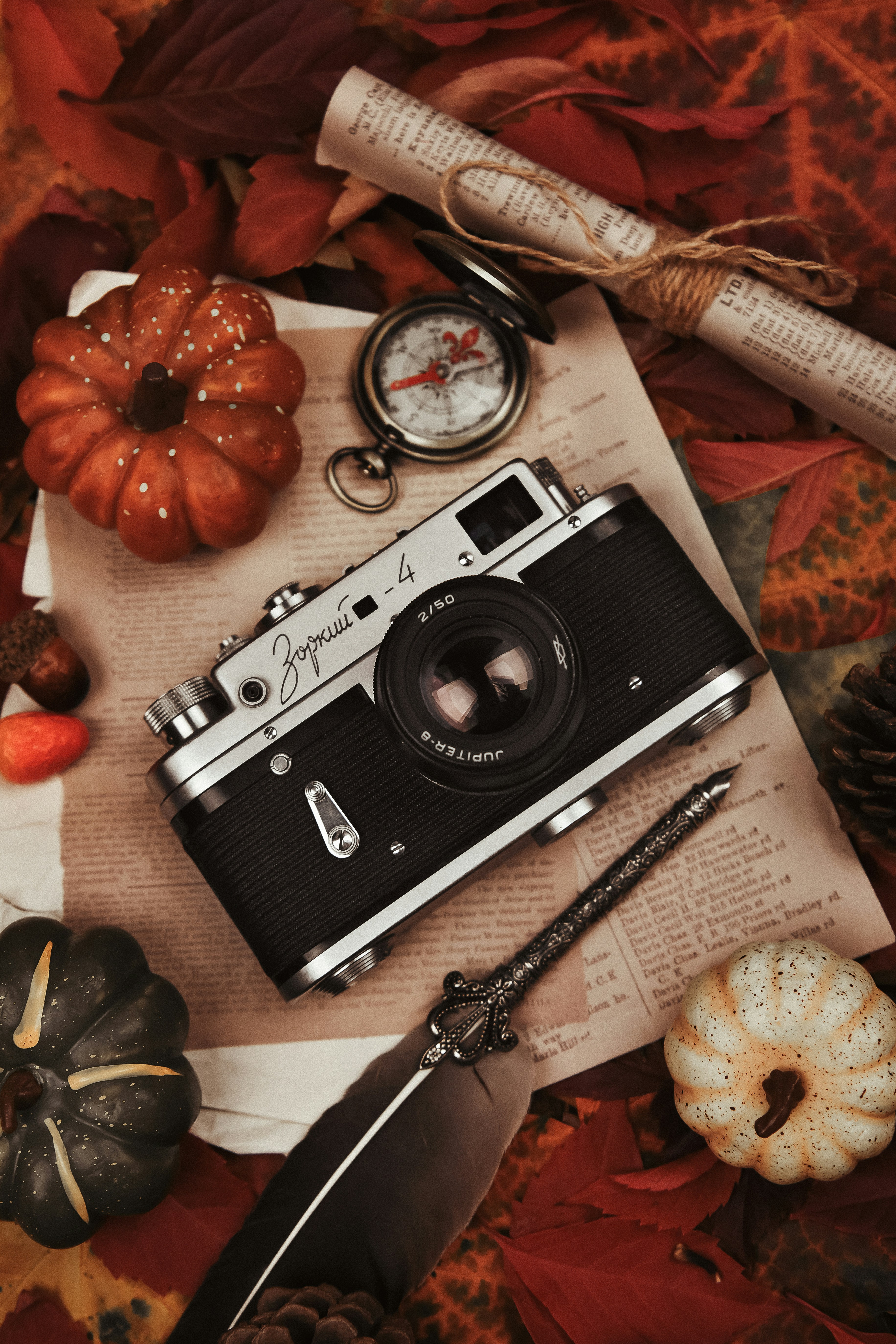 Autumn Relic: A Vintage Pentax-like Rangefinder Amid Leaves, Pumpkins, and Memorabilia
