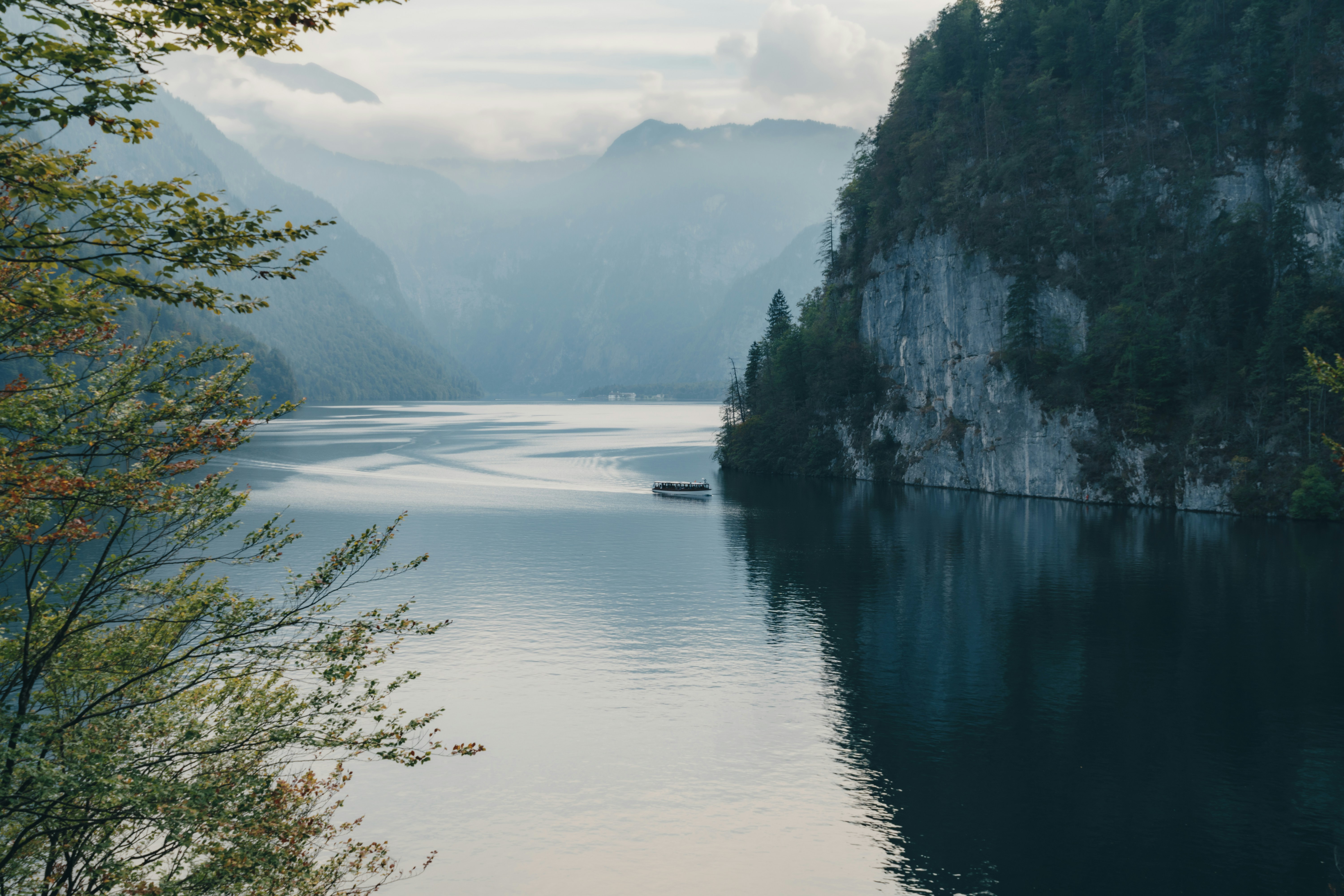 Silent Fjord: A Boat Drifts Between Carved Cliffs