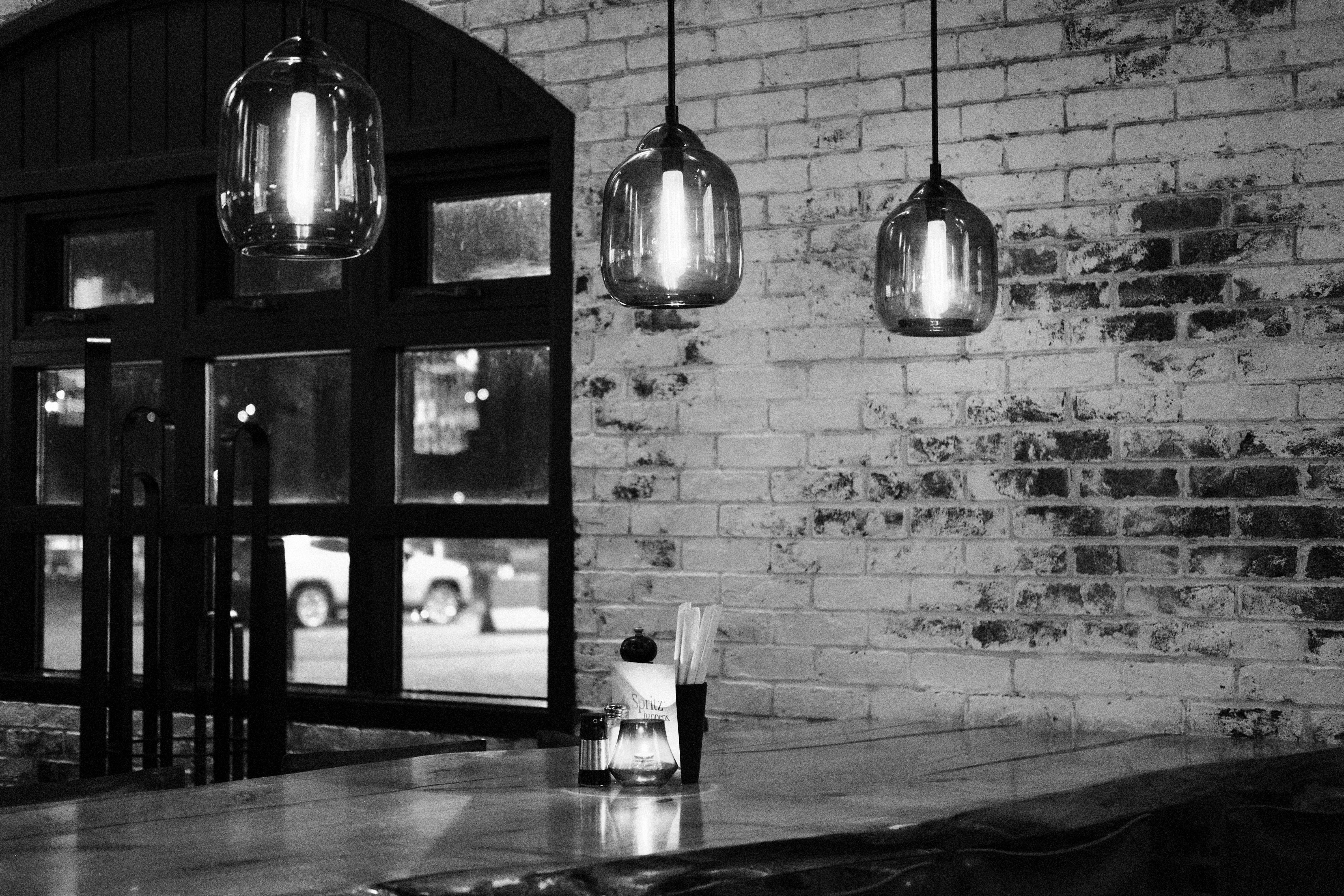 Empty Bar at Dusk: A Quiet Moment by the Brick Wall