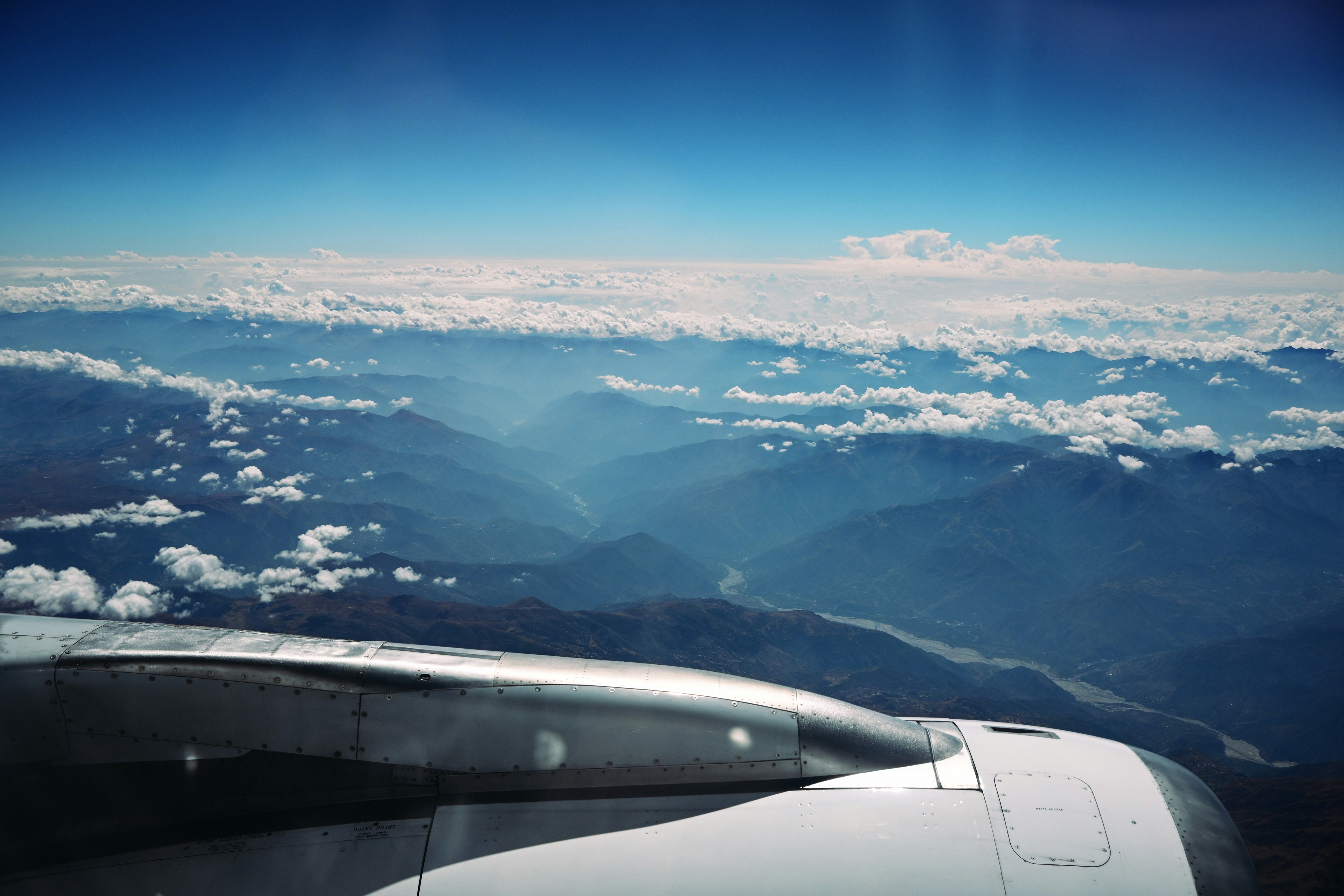 Above the Sea of Clouds: Wingtip View Over Mountain Veils