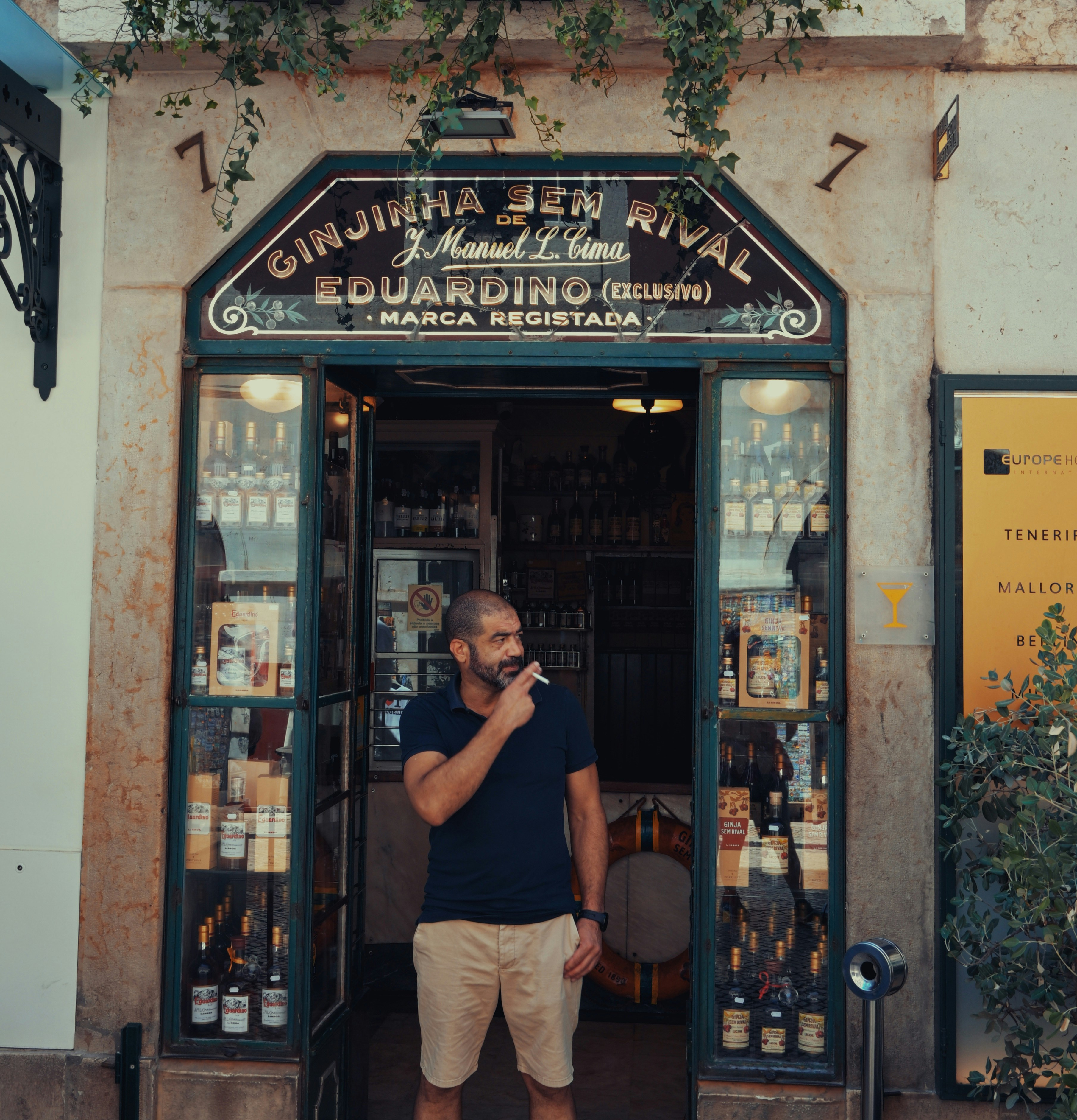 Cigar in hand, shop doorway framing a brewer’s doorway