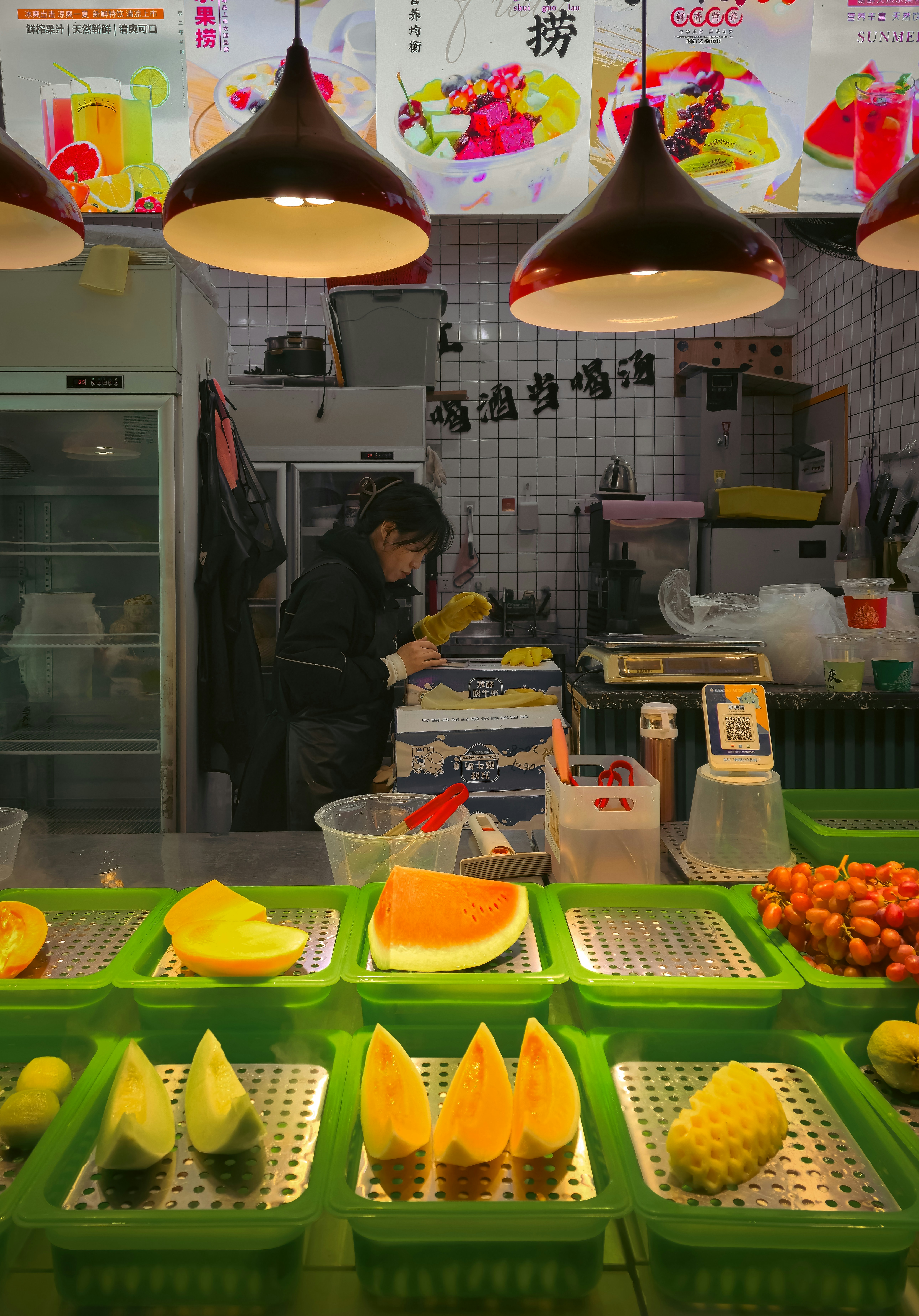 Market Stand Slice: Fresh Watermelon and Green Produce Under Warm Pendant Lights