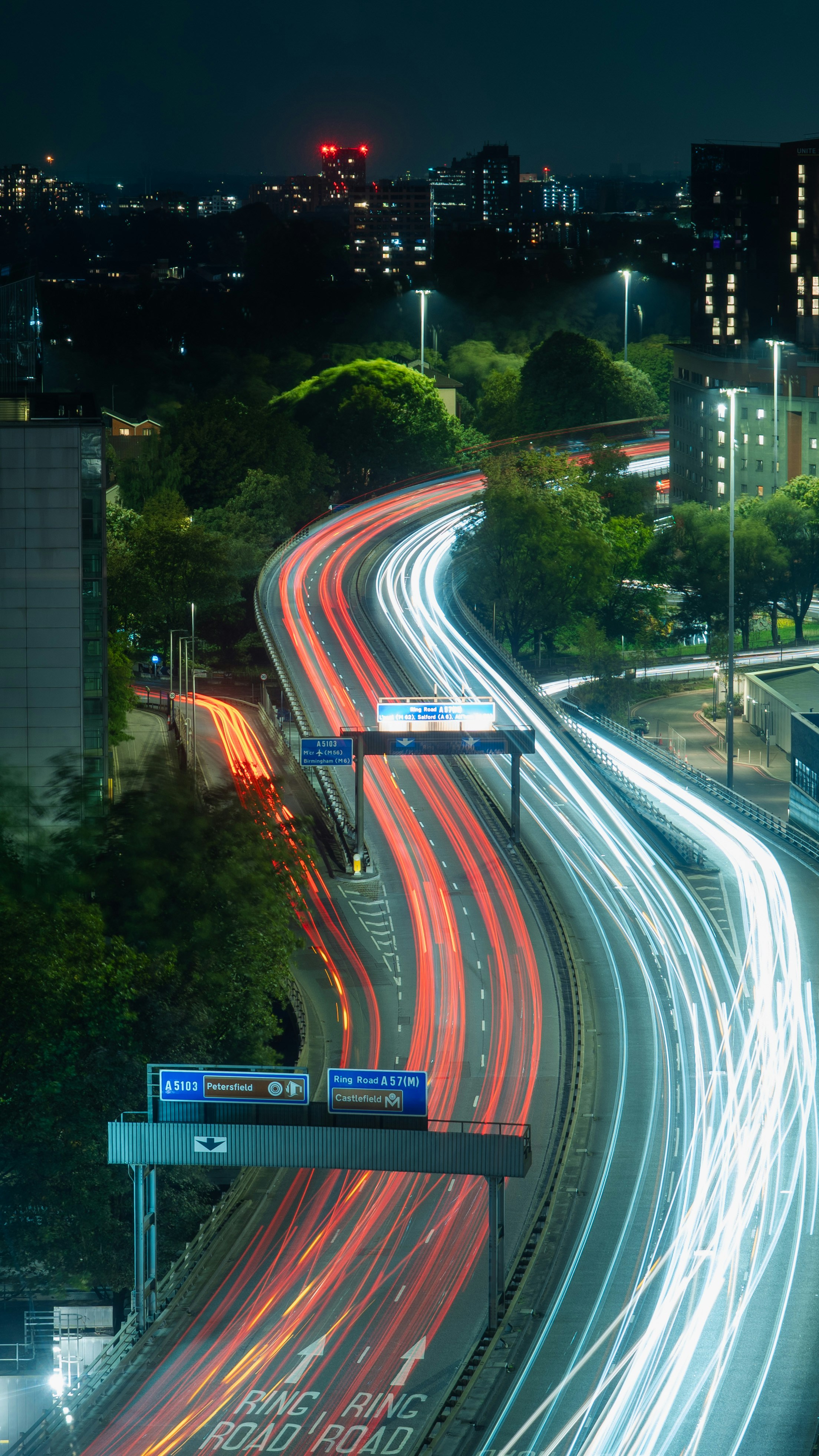 Neon Serpents: A Nighttime City Highway in Light Trails